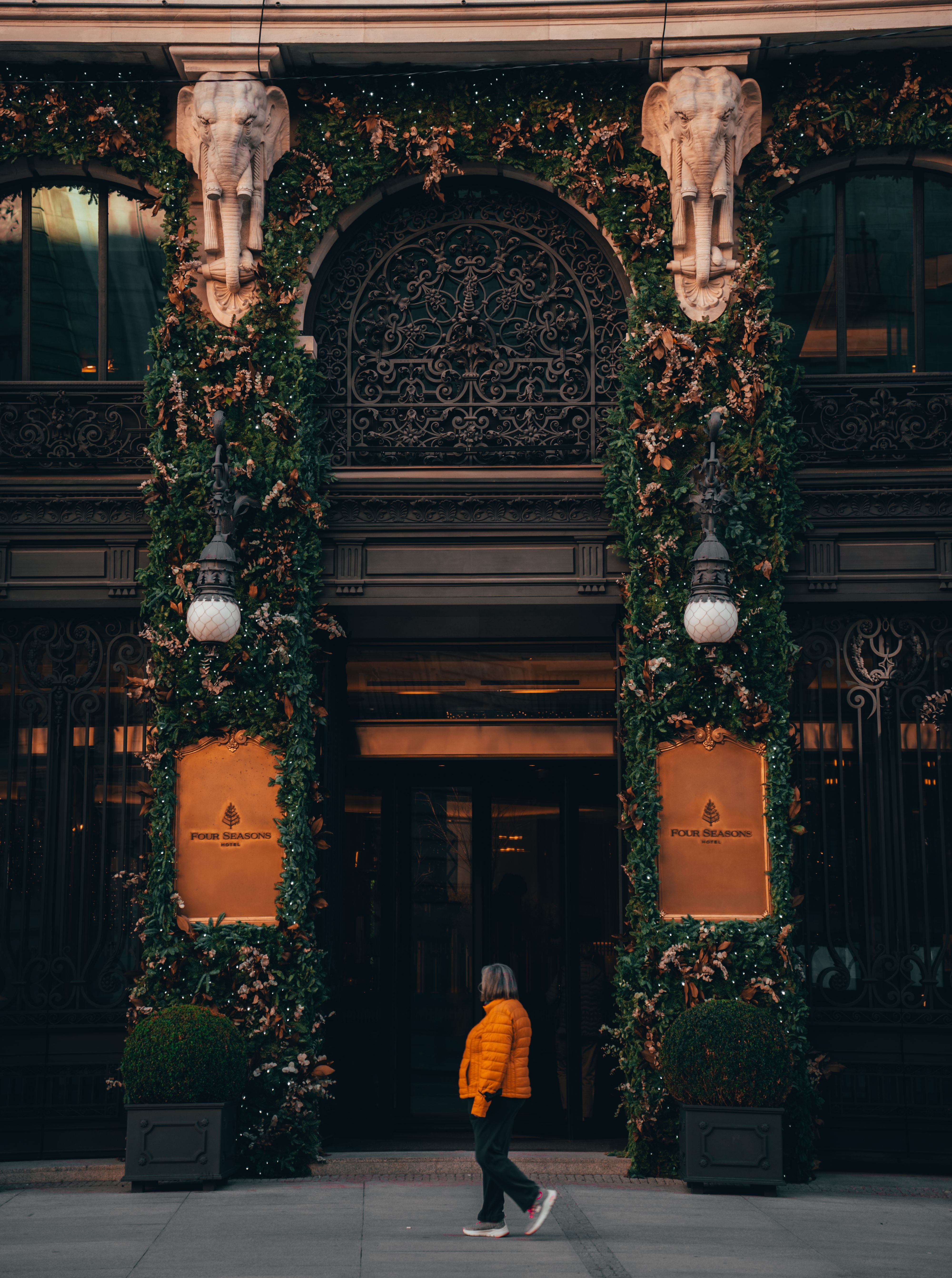 Woman Walking by Hotel Entrance · Free Stock Photo