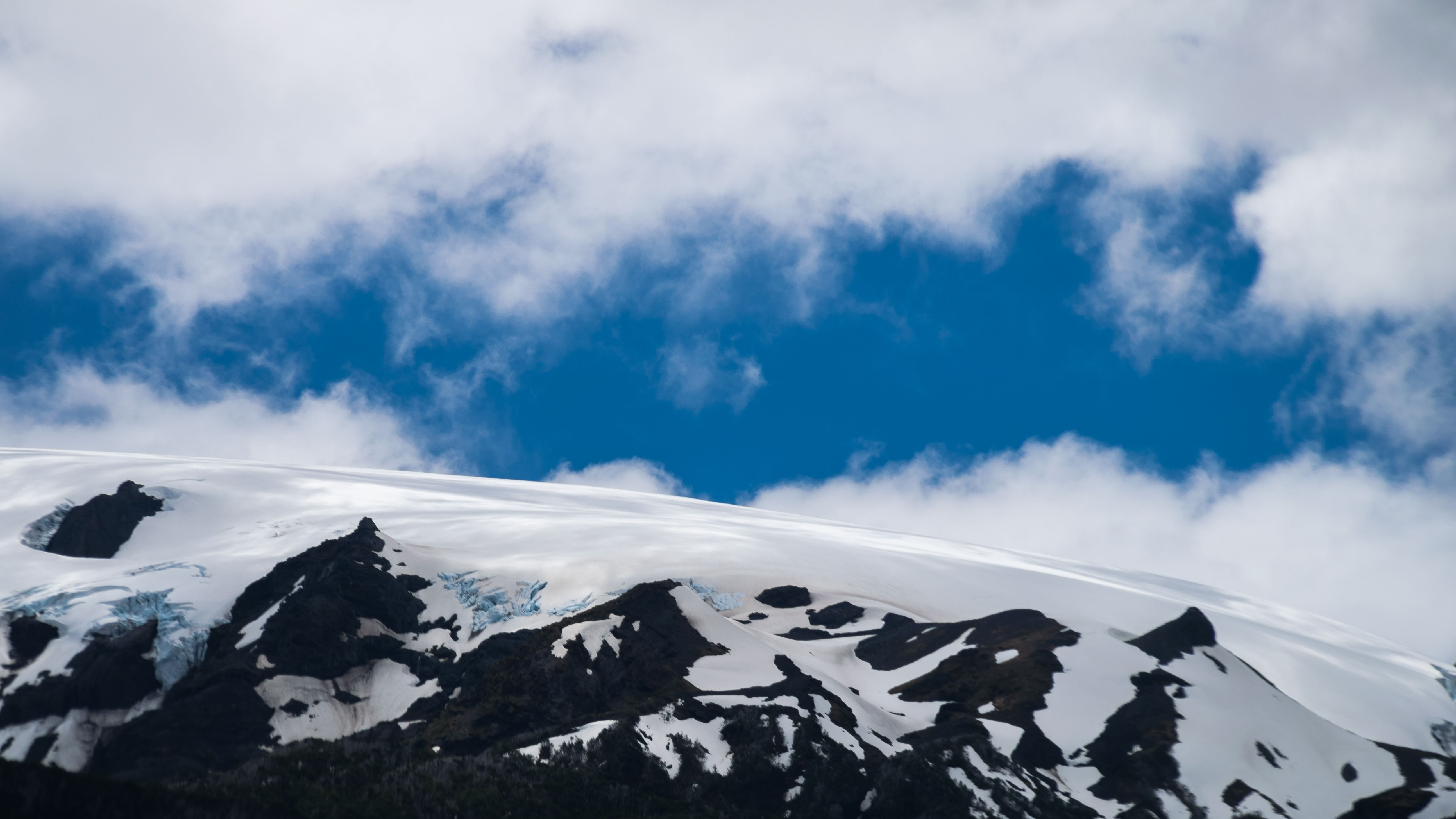 Cape of Snow on Mountain Ridge · Free Stock Photo