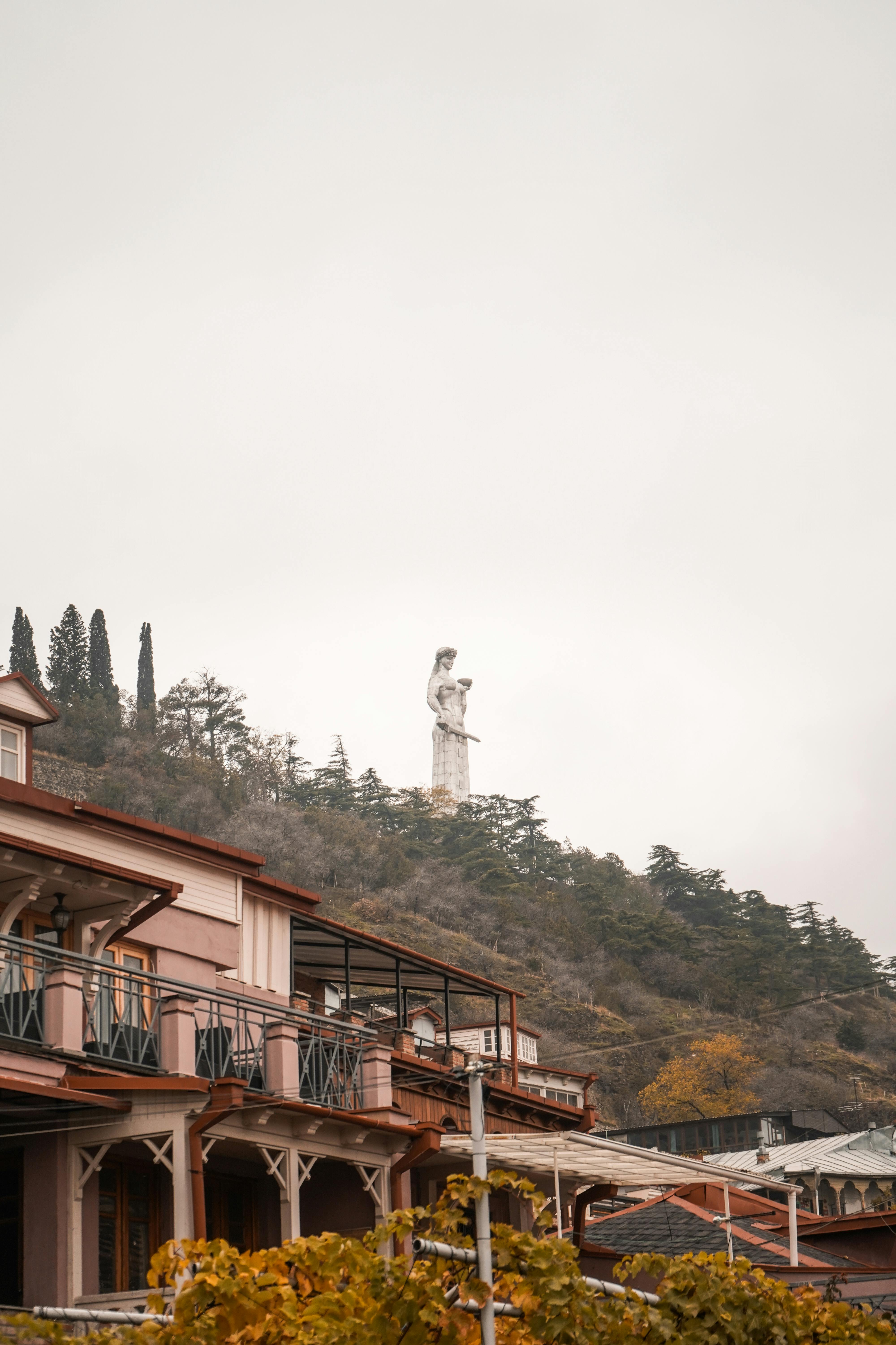 A Woman Statue Surrounded by Green Trees · Free Stock Photo