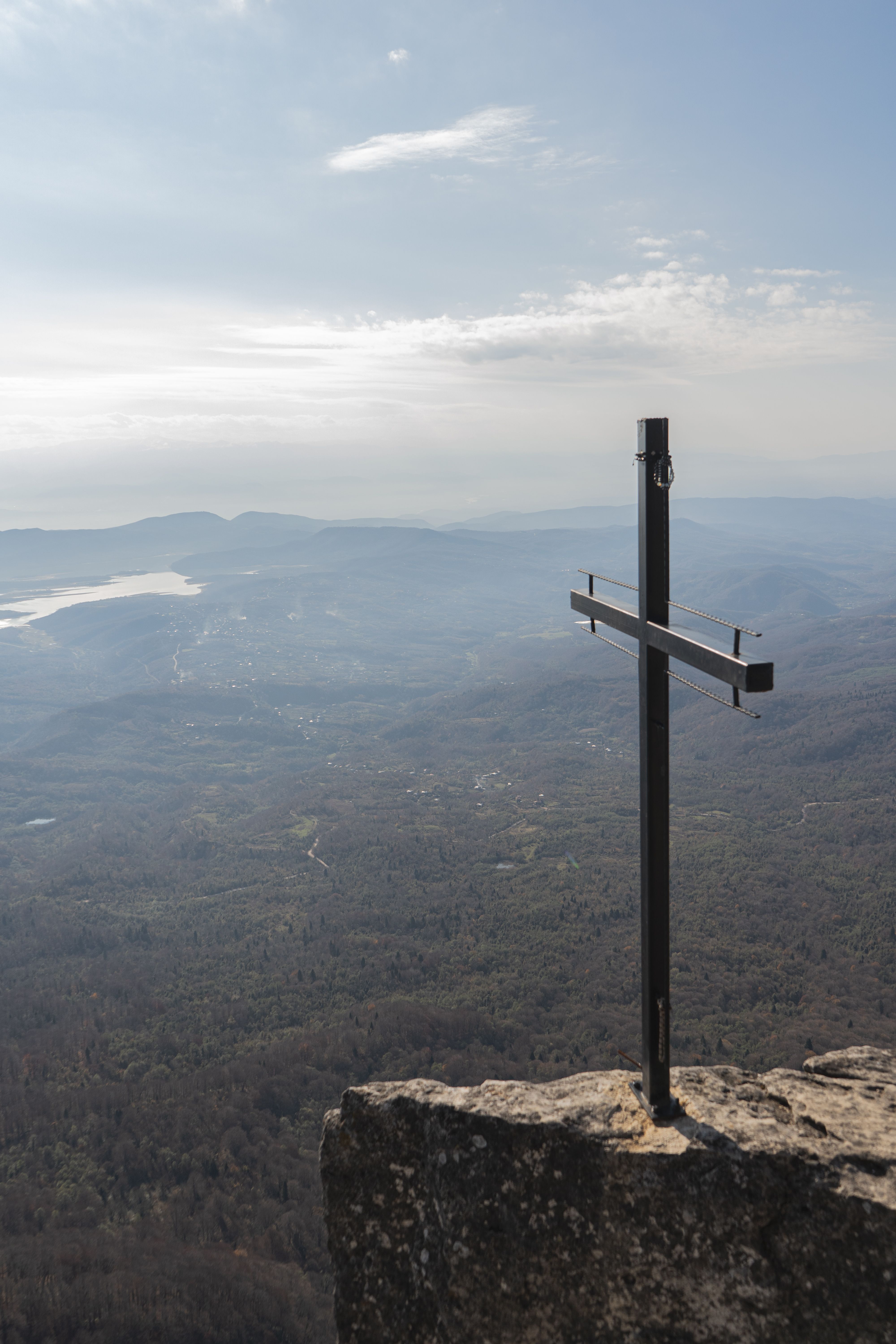 Cross on Rock over Forest · Free Stock Photo