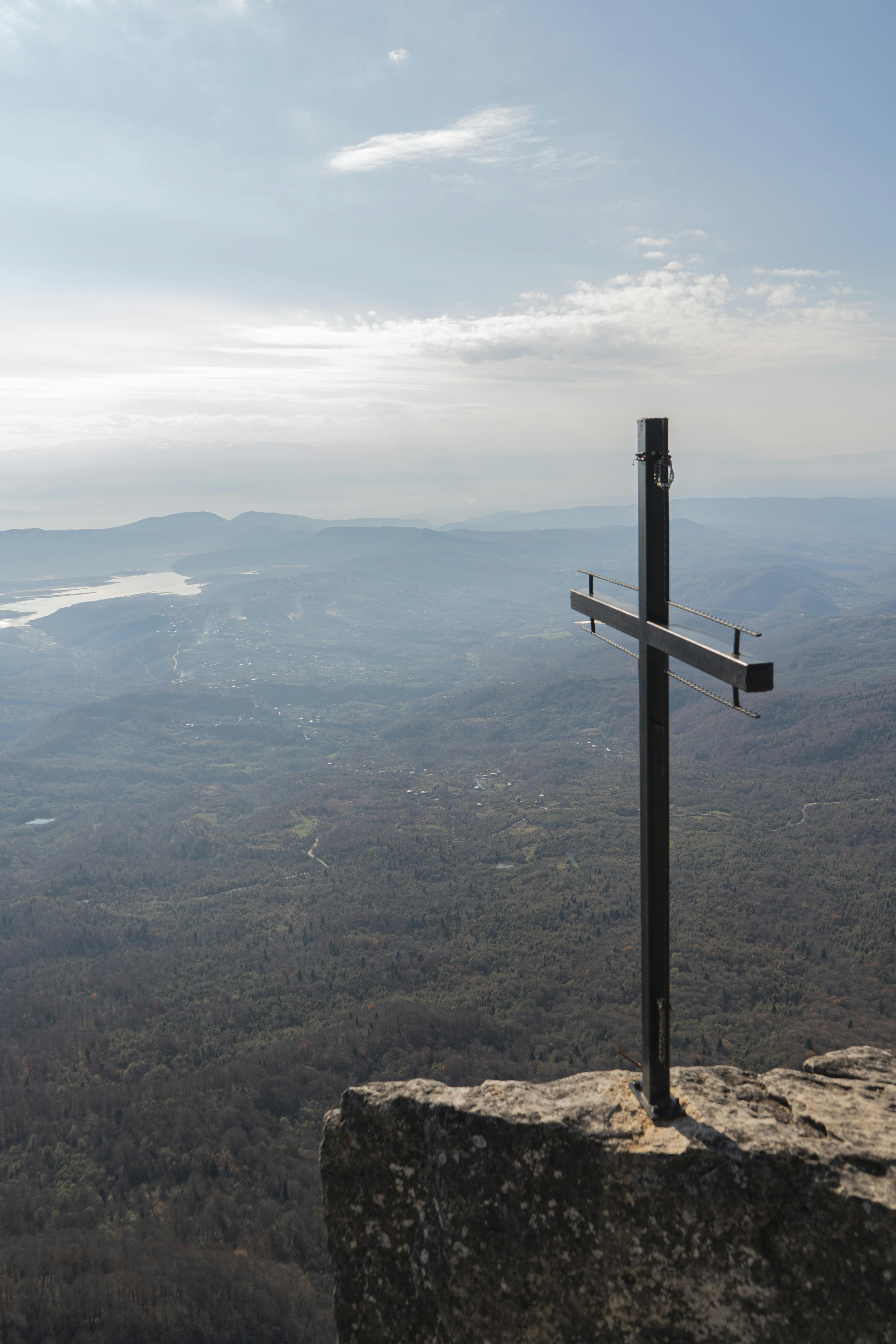 Cross on Rock over Forest · Free Stock Photo