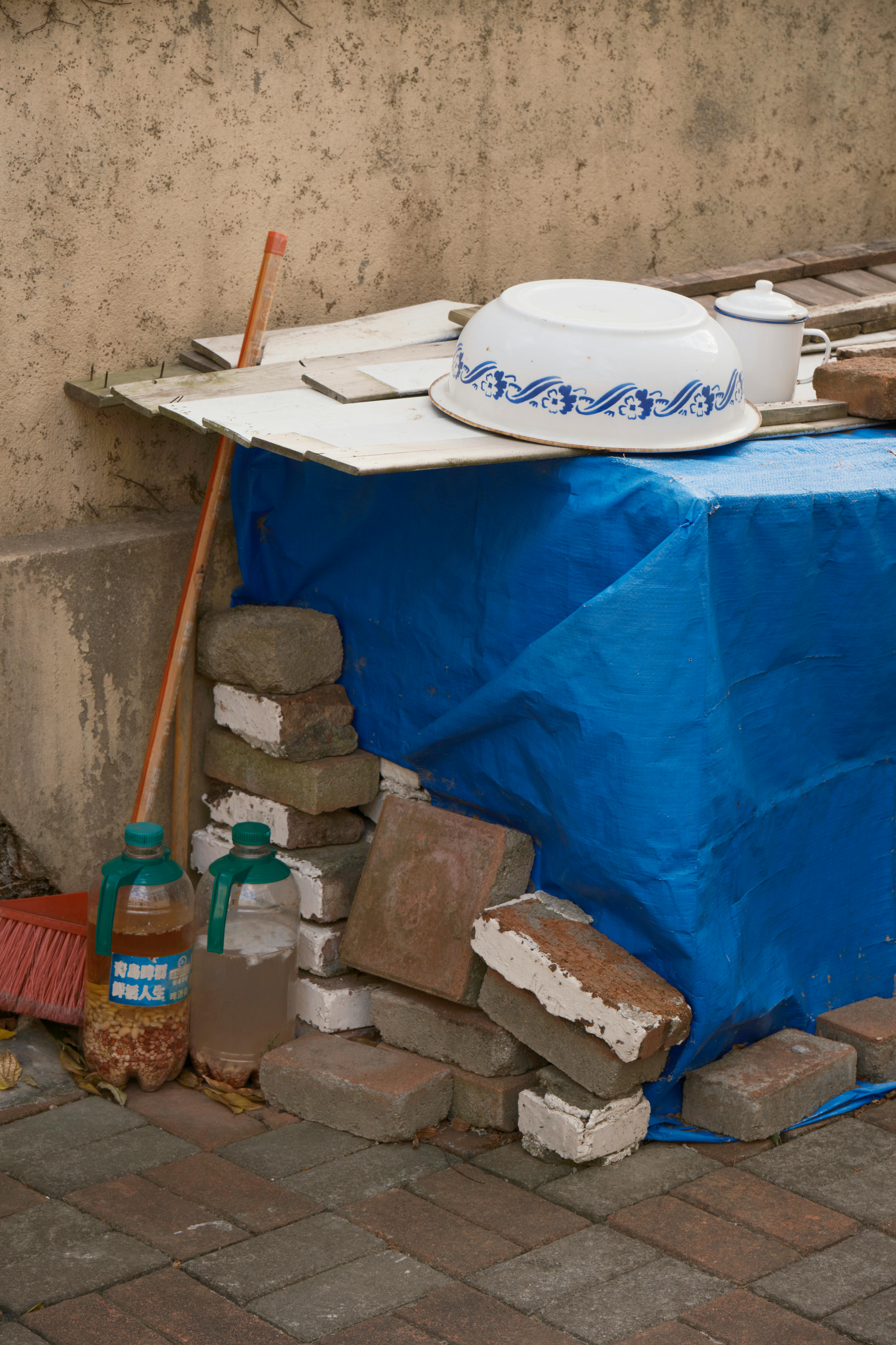 Broom Standing by a Bunch of Bricks · Free Stock Photo