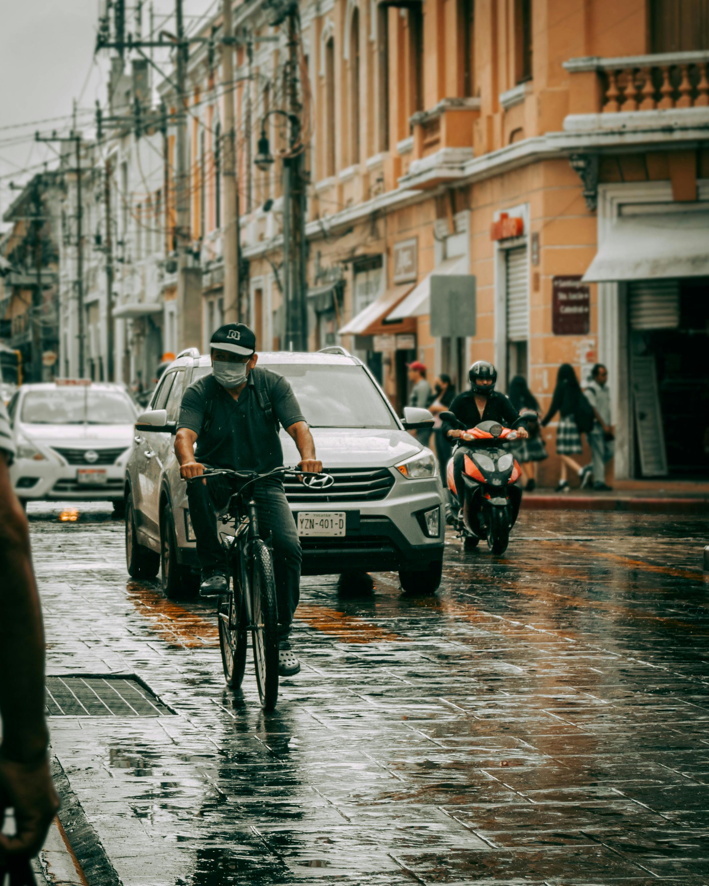 Man Riding a Bicycle in the Rain · Free Stock Photo
