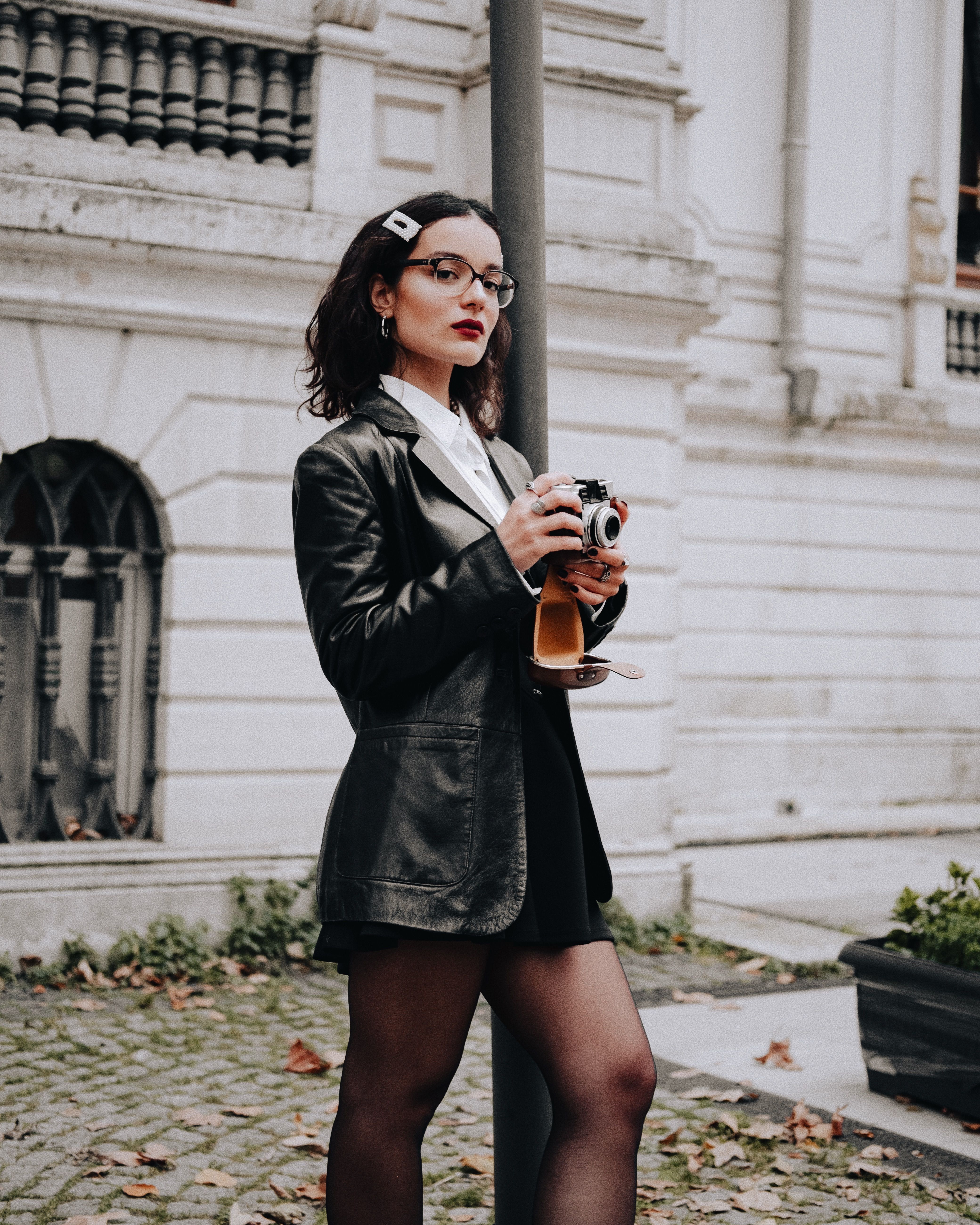 Woman in Jacket Posing with Camera · Free Stock Photo