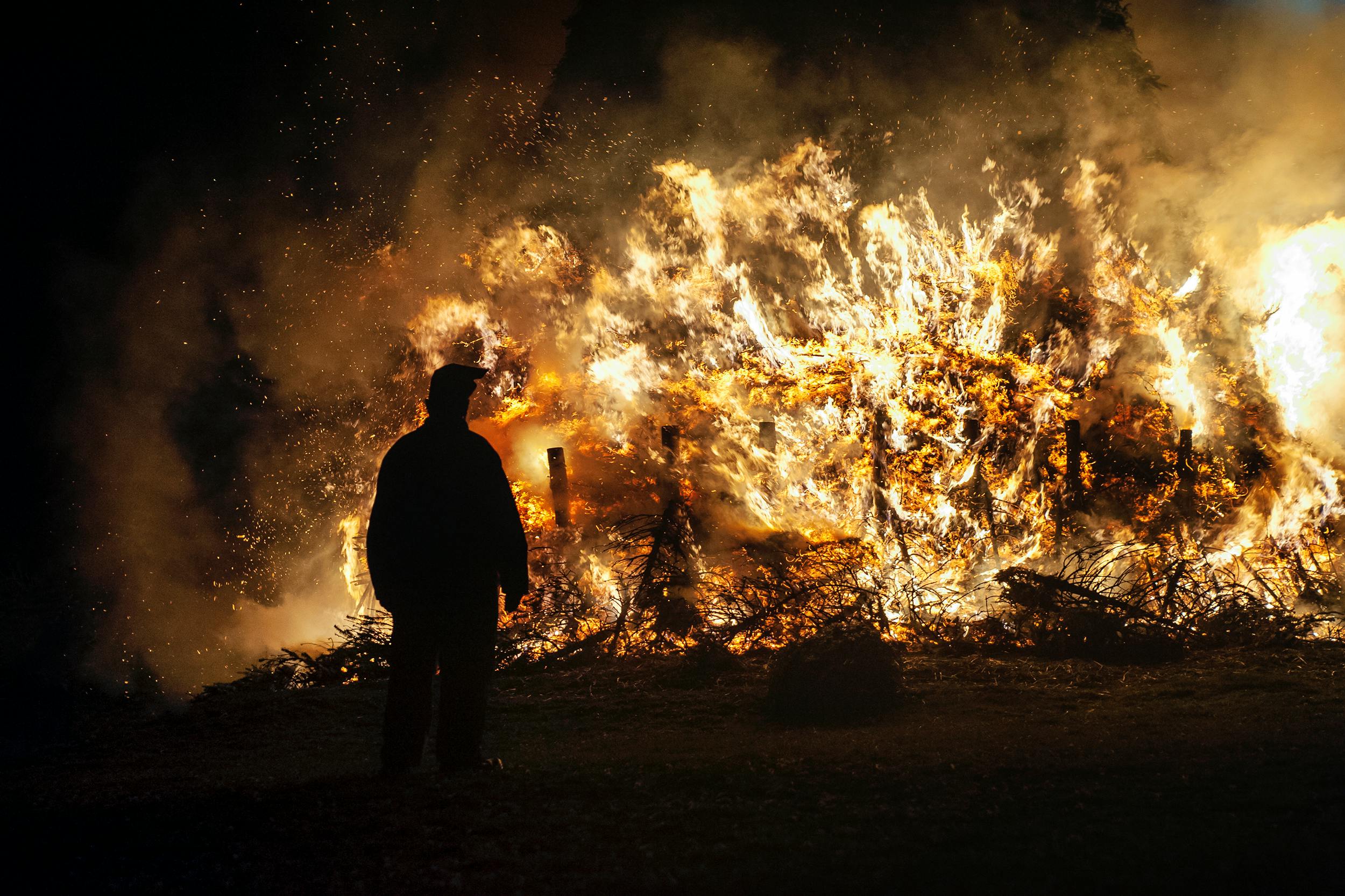 Burning newspaper revealing man face on other side · Free Stock Photo