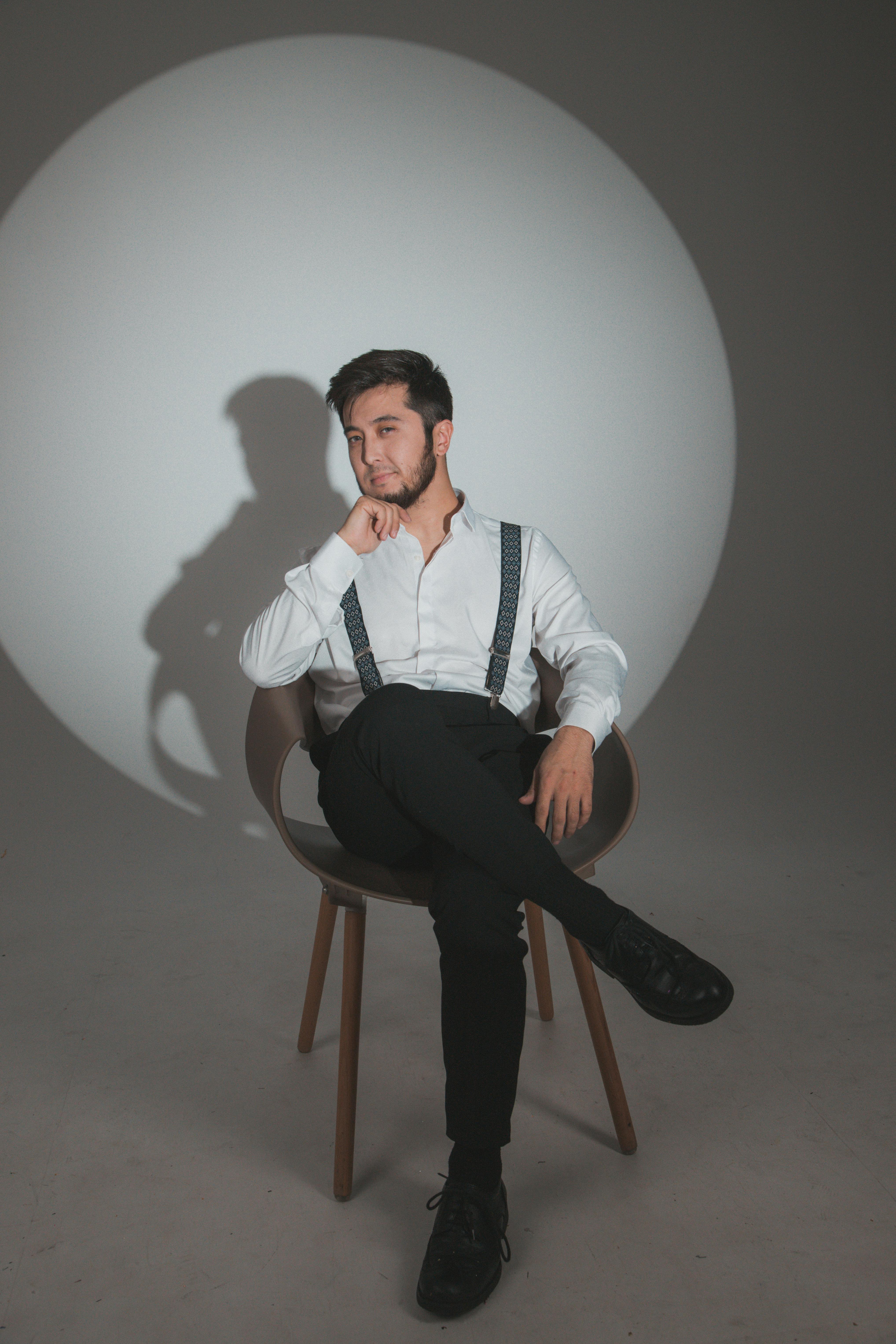 Man Sitting on Wooden Chair · Free Stock Photo