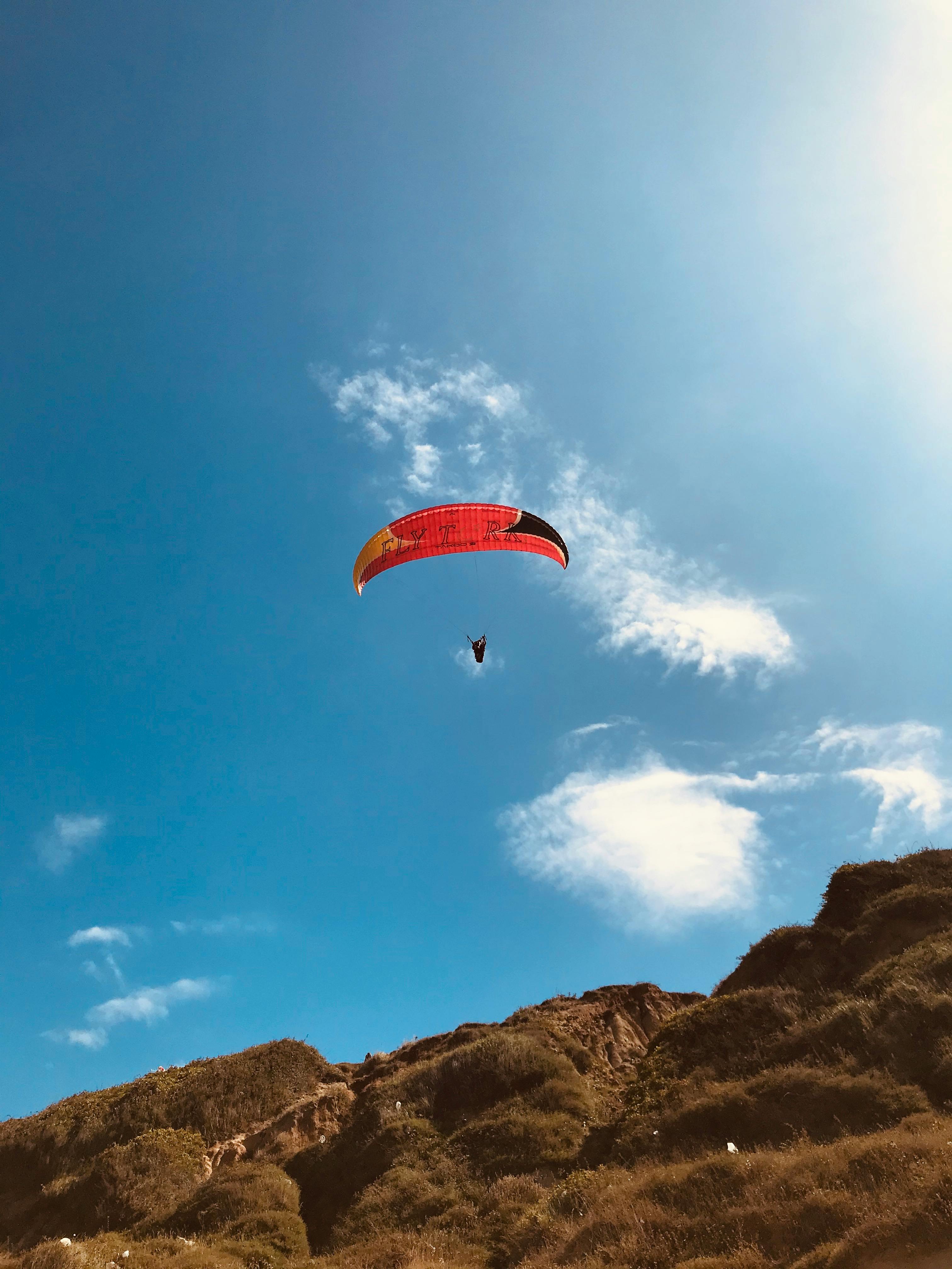 Low Angle Shot of Paraglider Under Blue Sky · Free Stock Photo