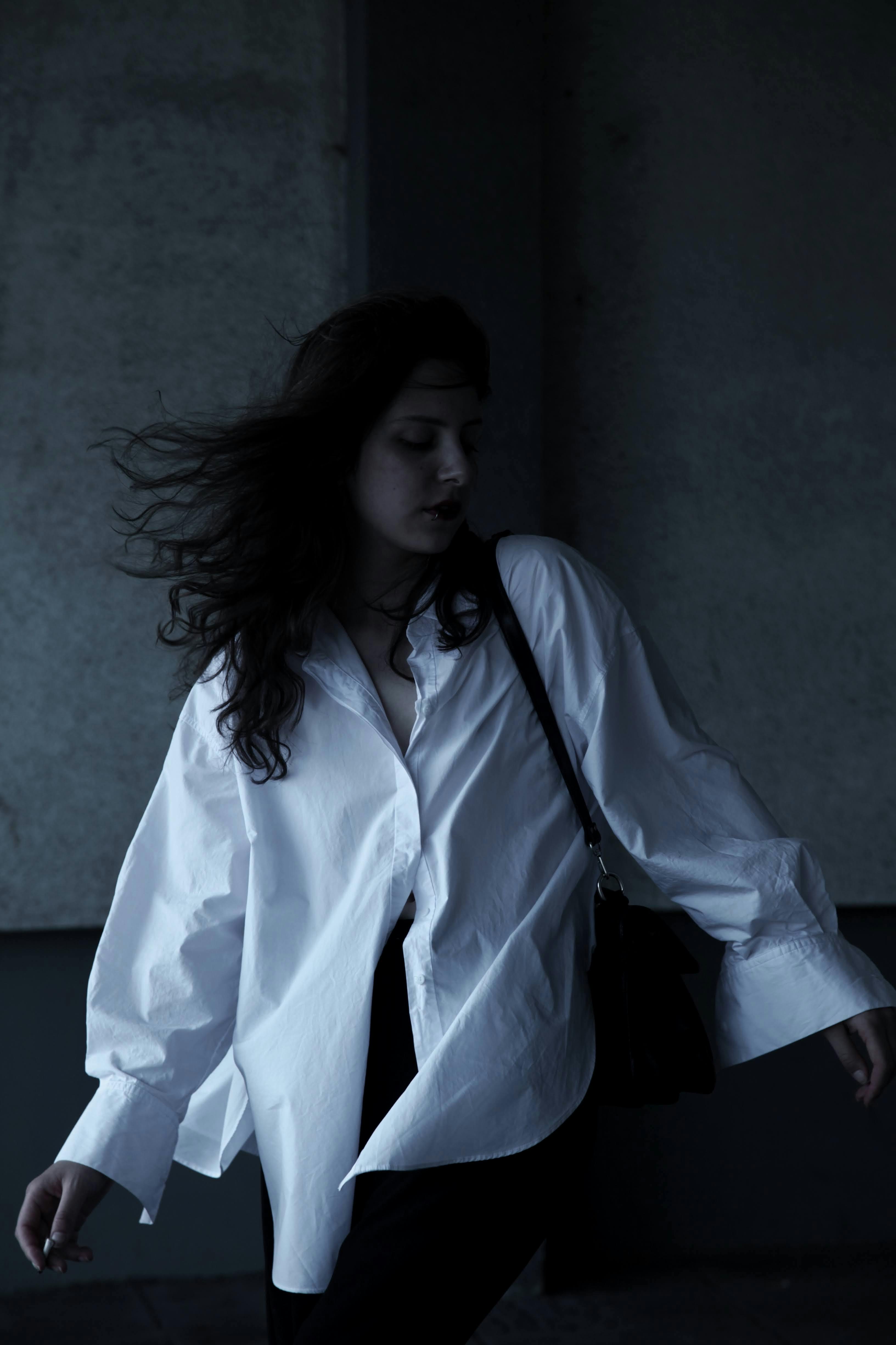 Brunette Woman Dancing with Messy Hair · Free Stock Photo