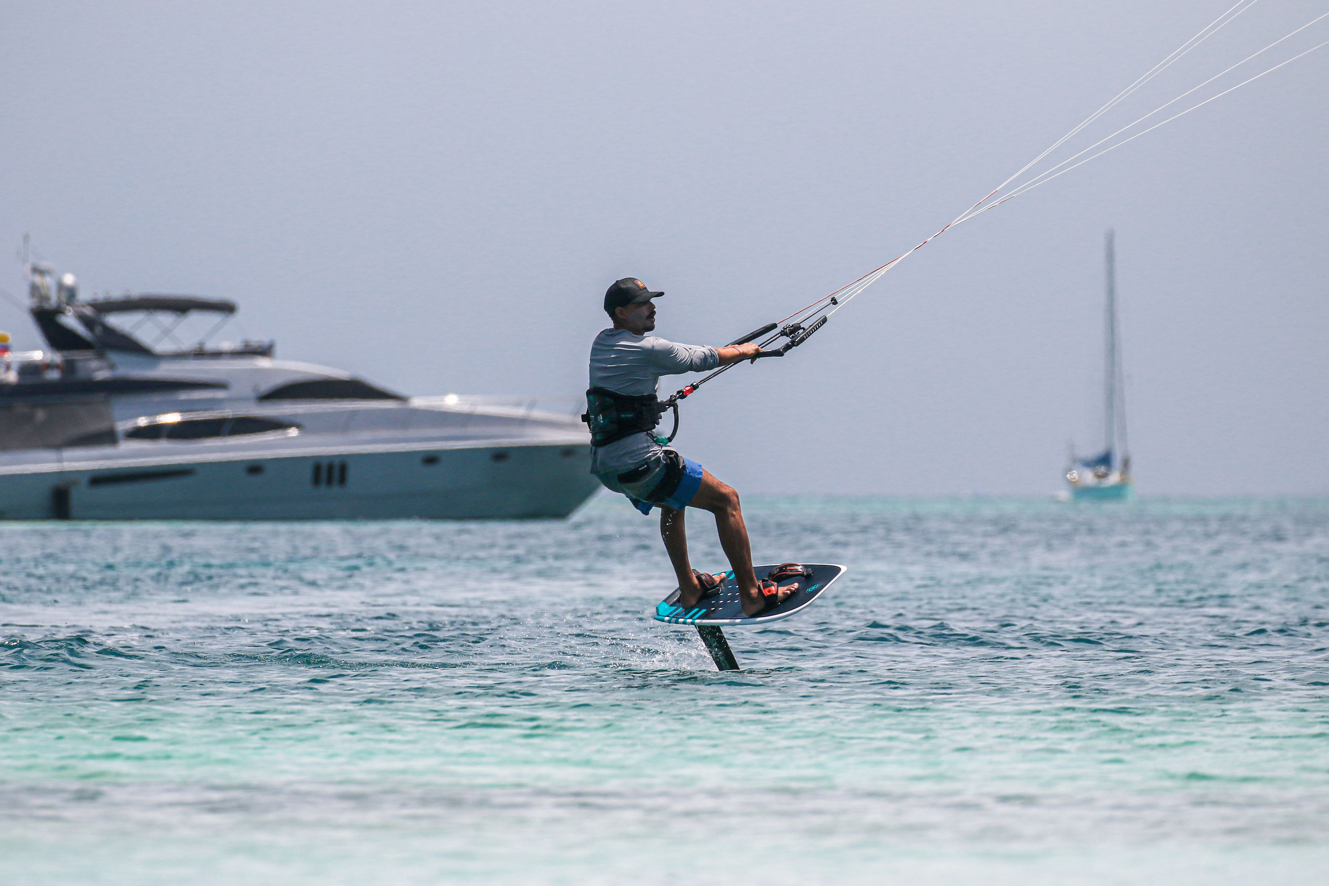 Man Holding a Wakeboard Running on the Beach · Free Stock Photo
