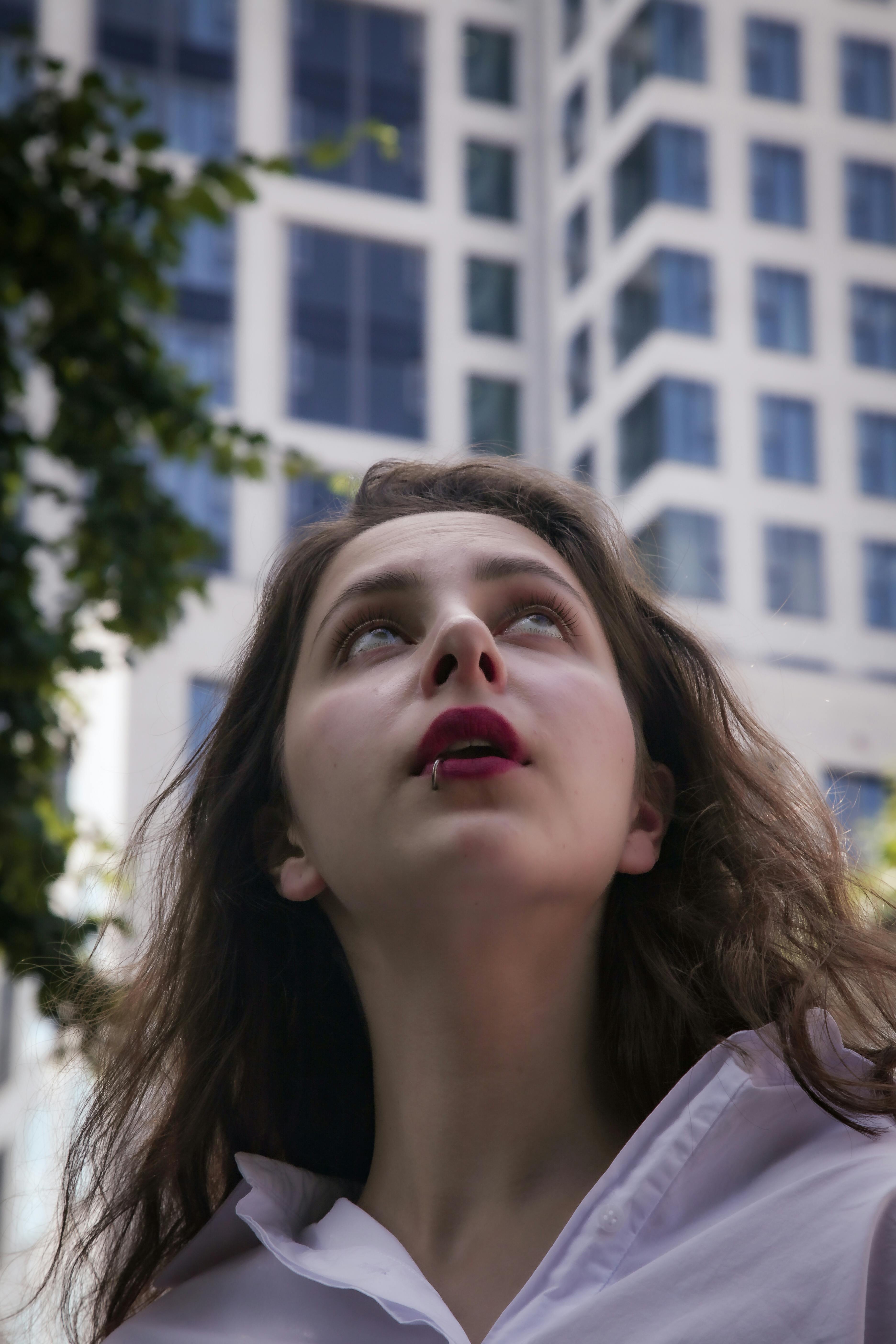 Woman in a City Looking Up · Free Stock Photo