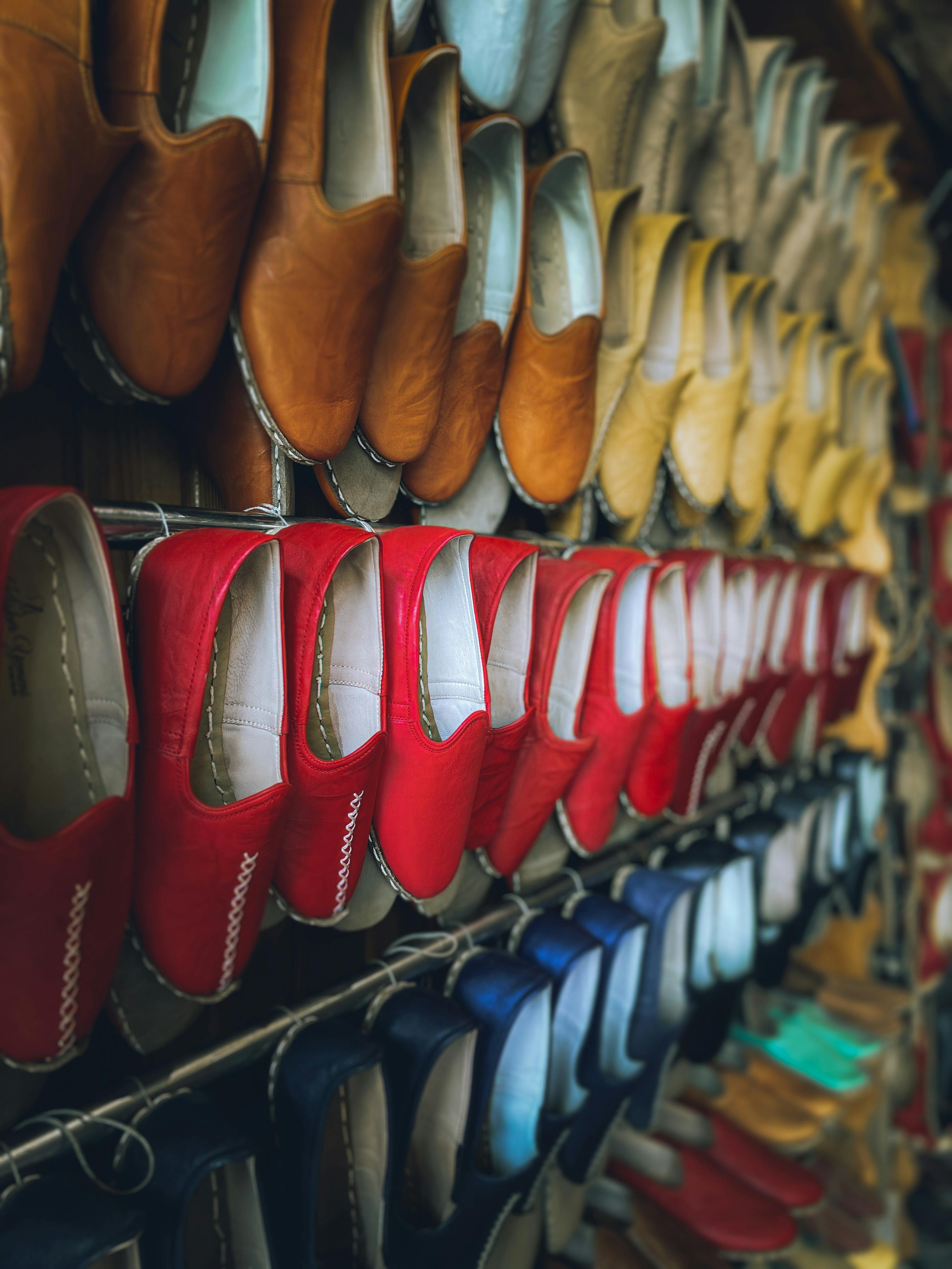 Traditional Babouche Shoes Hanging on Racks in a Store · Free Stock Photo