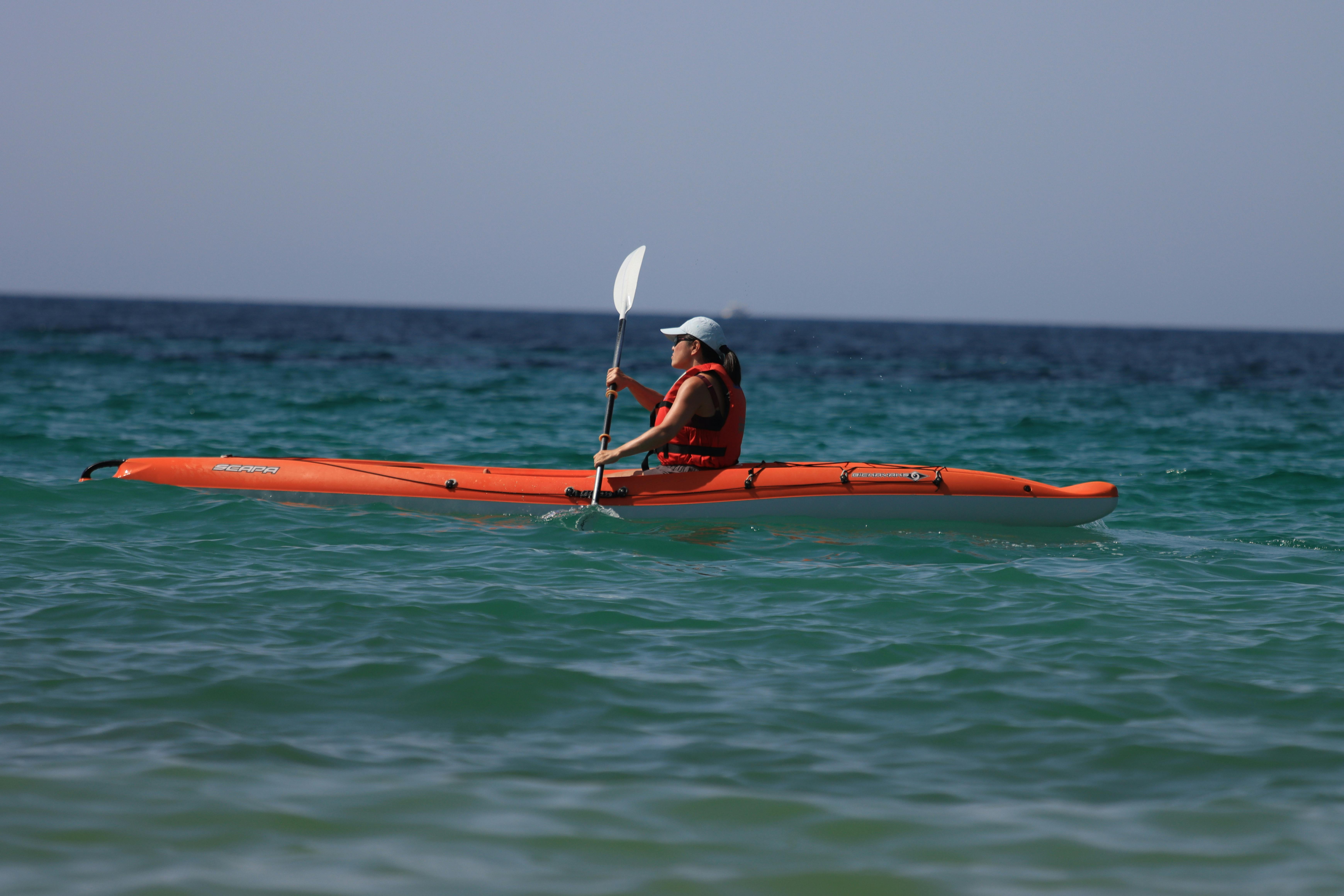 Photo of People Riding Kayaks Near Mountains · Free Stock Photo