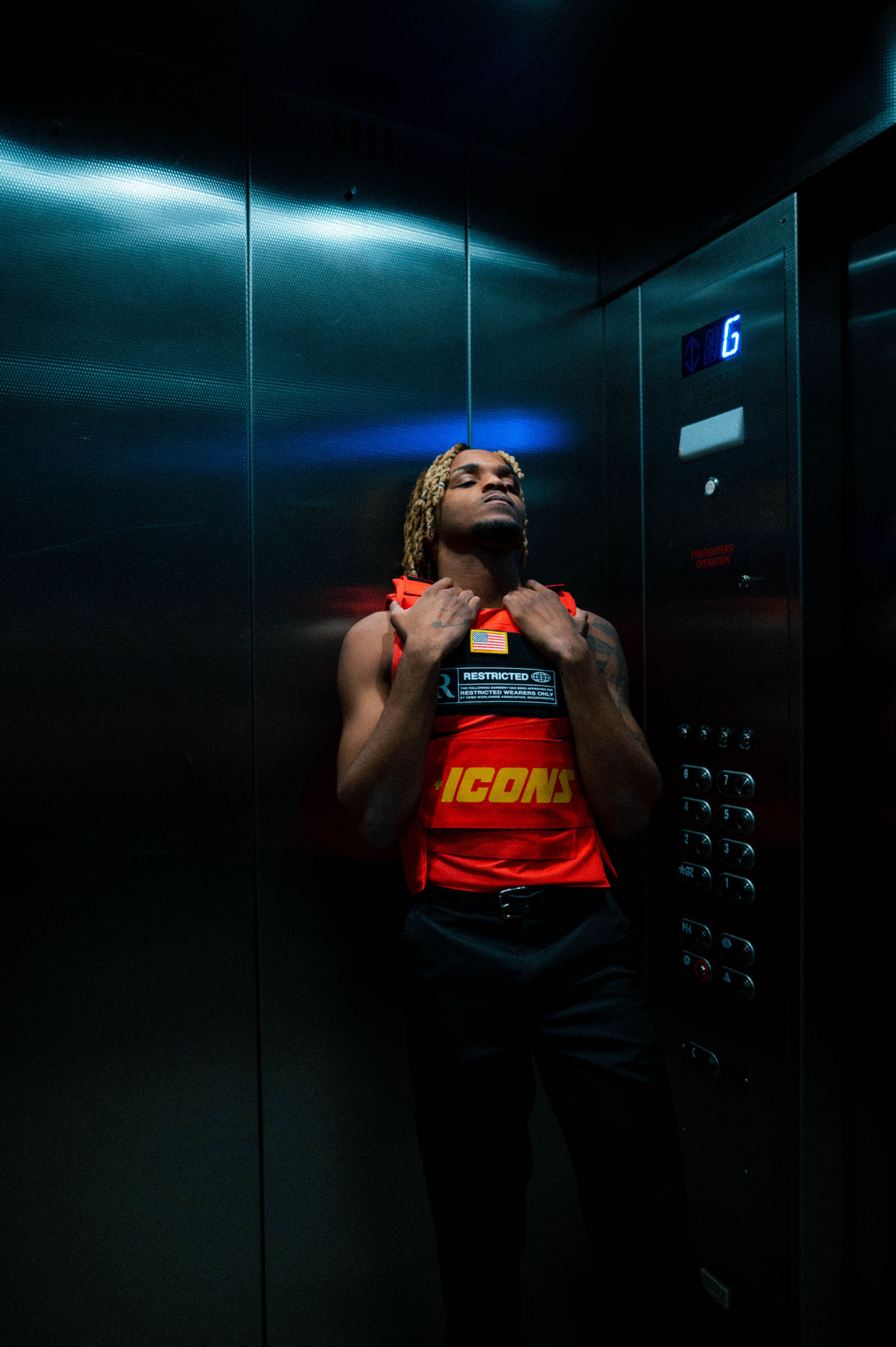 A Person in Elevator Pushing Crates on Trolley · Free Stock Photo
