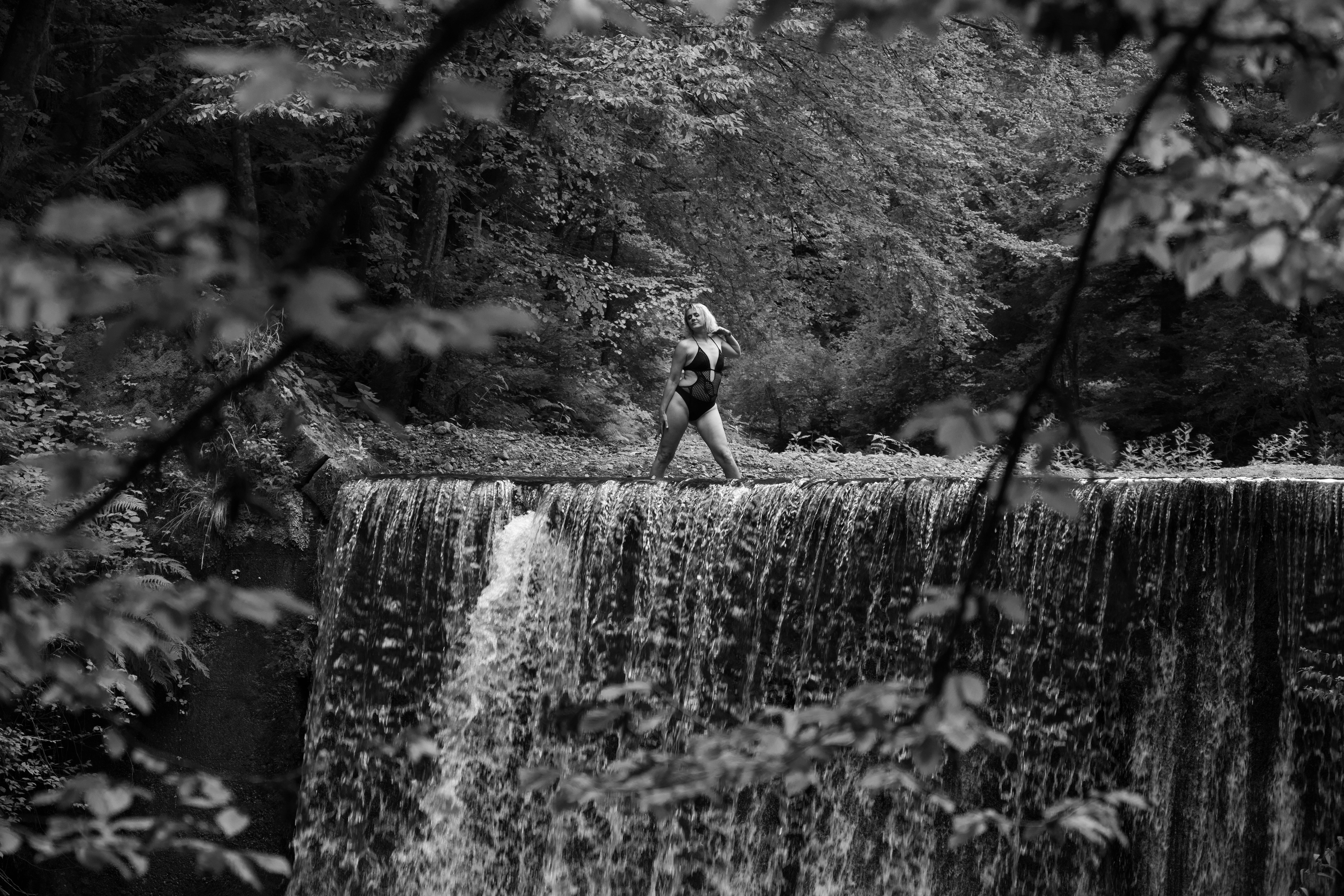 A Woman Standing on the Top of a Waterfall · Free Stock Photo