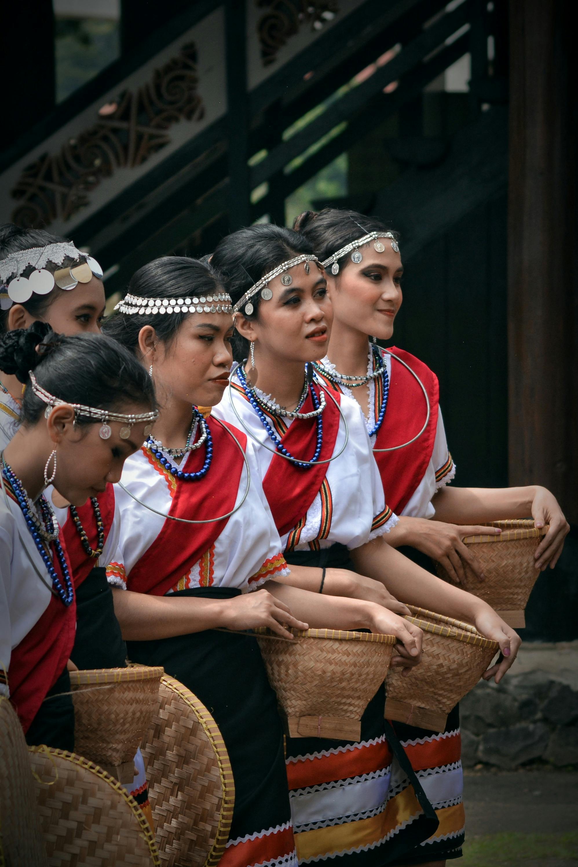 Women in Traditional Costumes Holding Baskets in Hands · Free Stock Photo