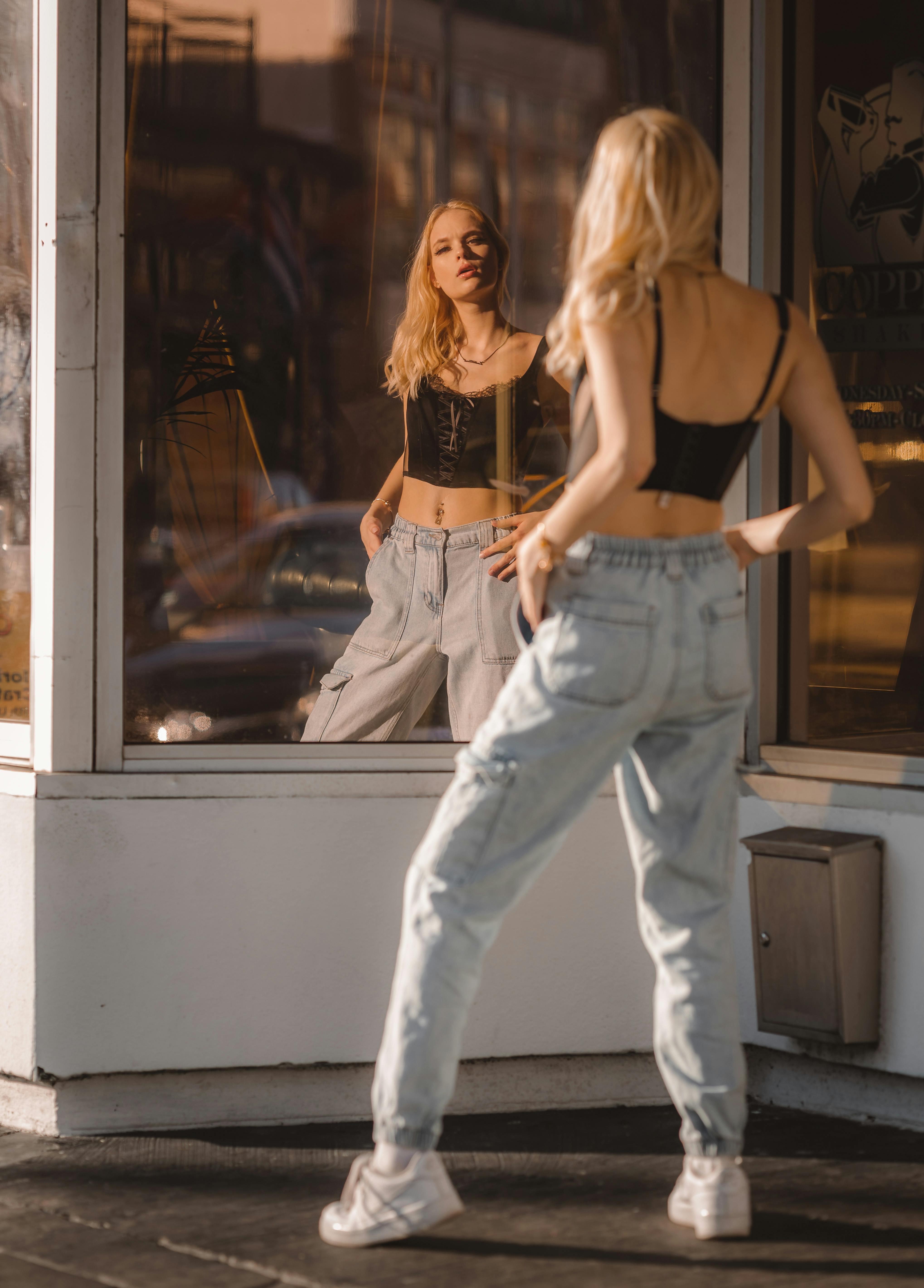 Woman Standing in Front of Glass Window · Free Stock Photo