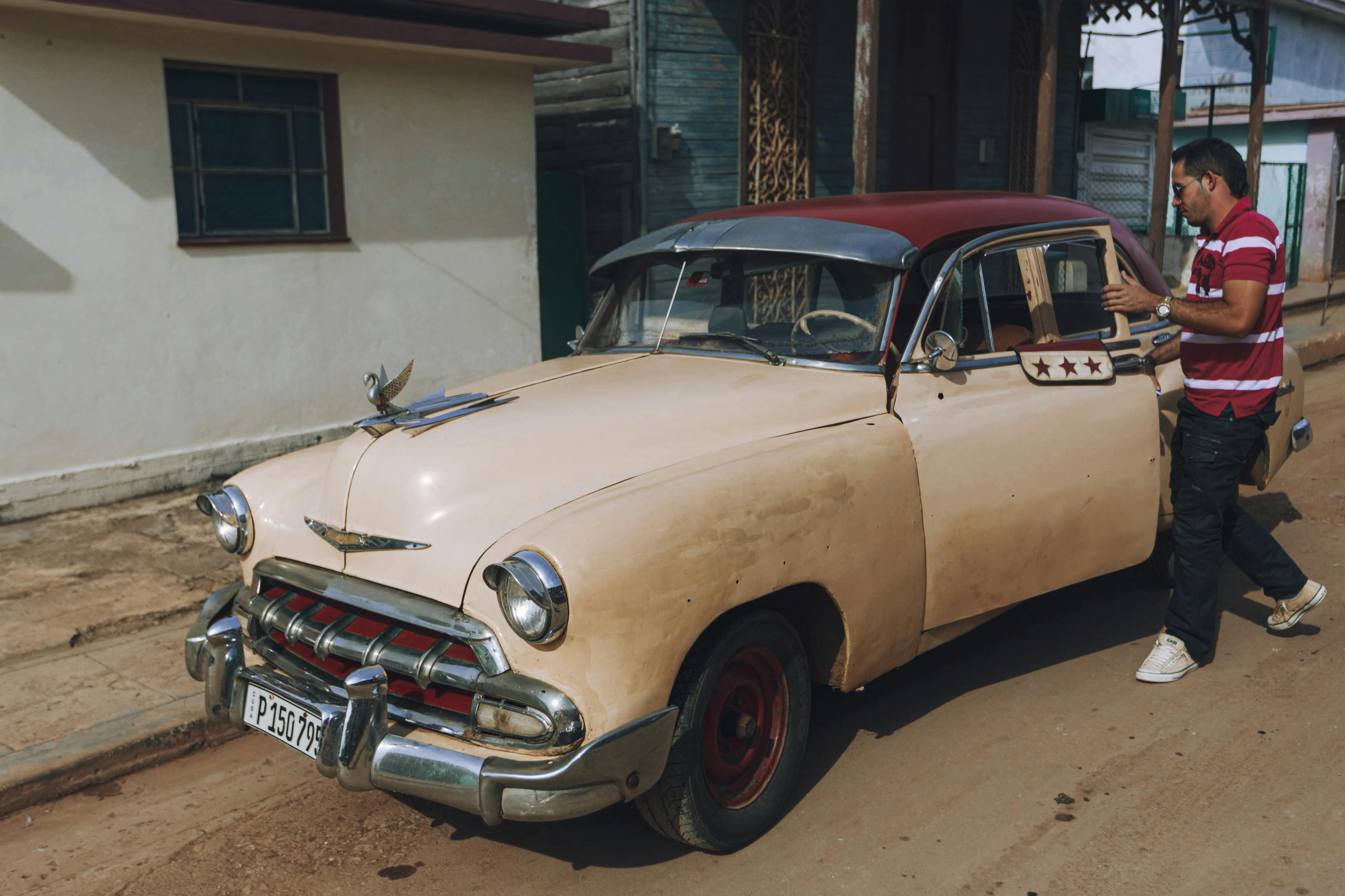 Man Closing a Vintage Car · Free Stock Photo
