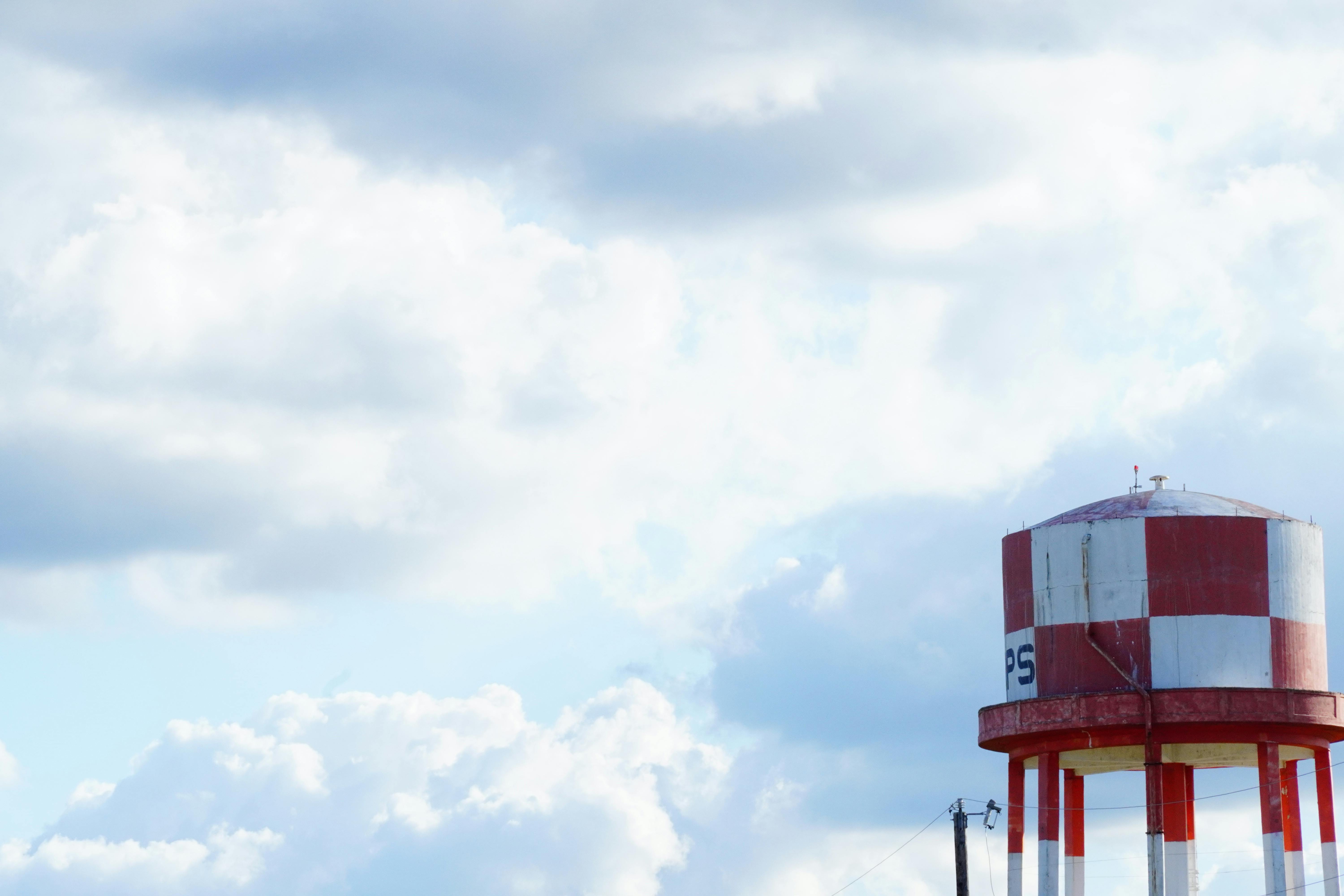 Checkered Red and White Water Tower Against the Blue Sky · Free Stock Photo