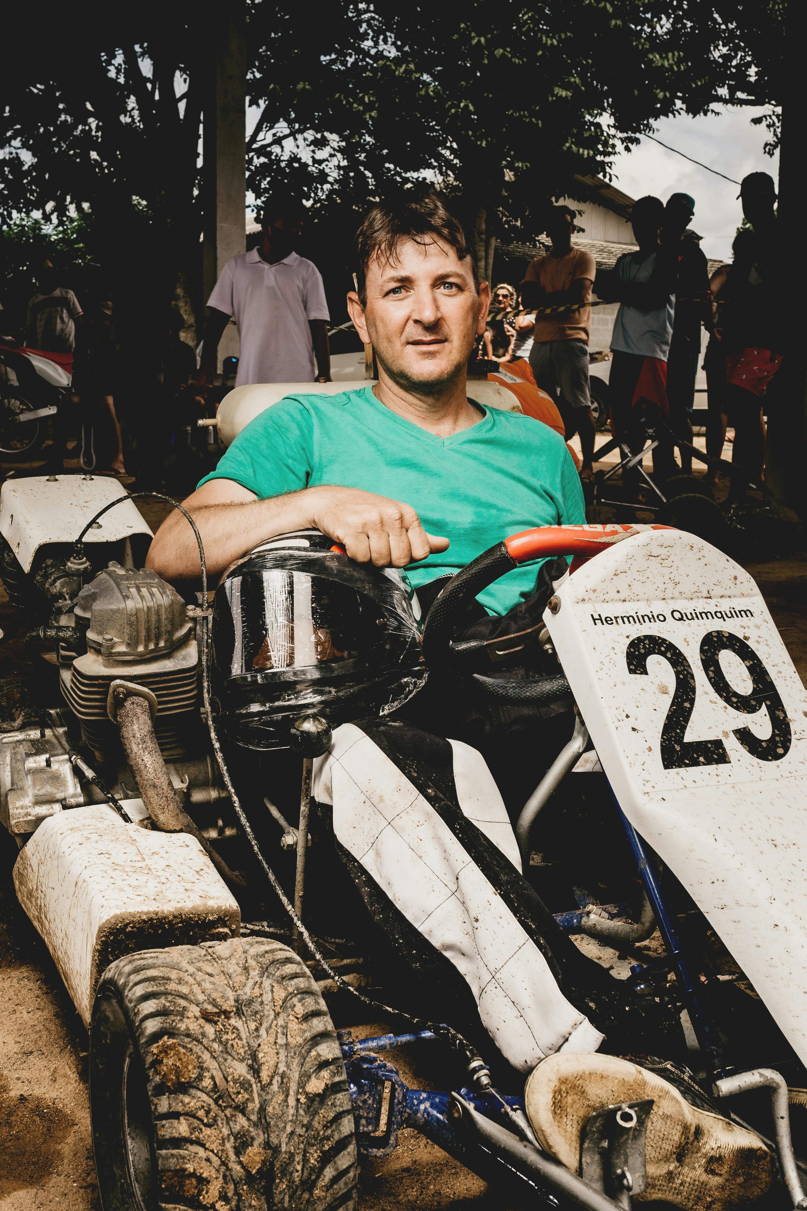 Man Riding a Go Kart and Holding a Helmet · Free Stock Photo