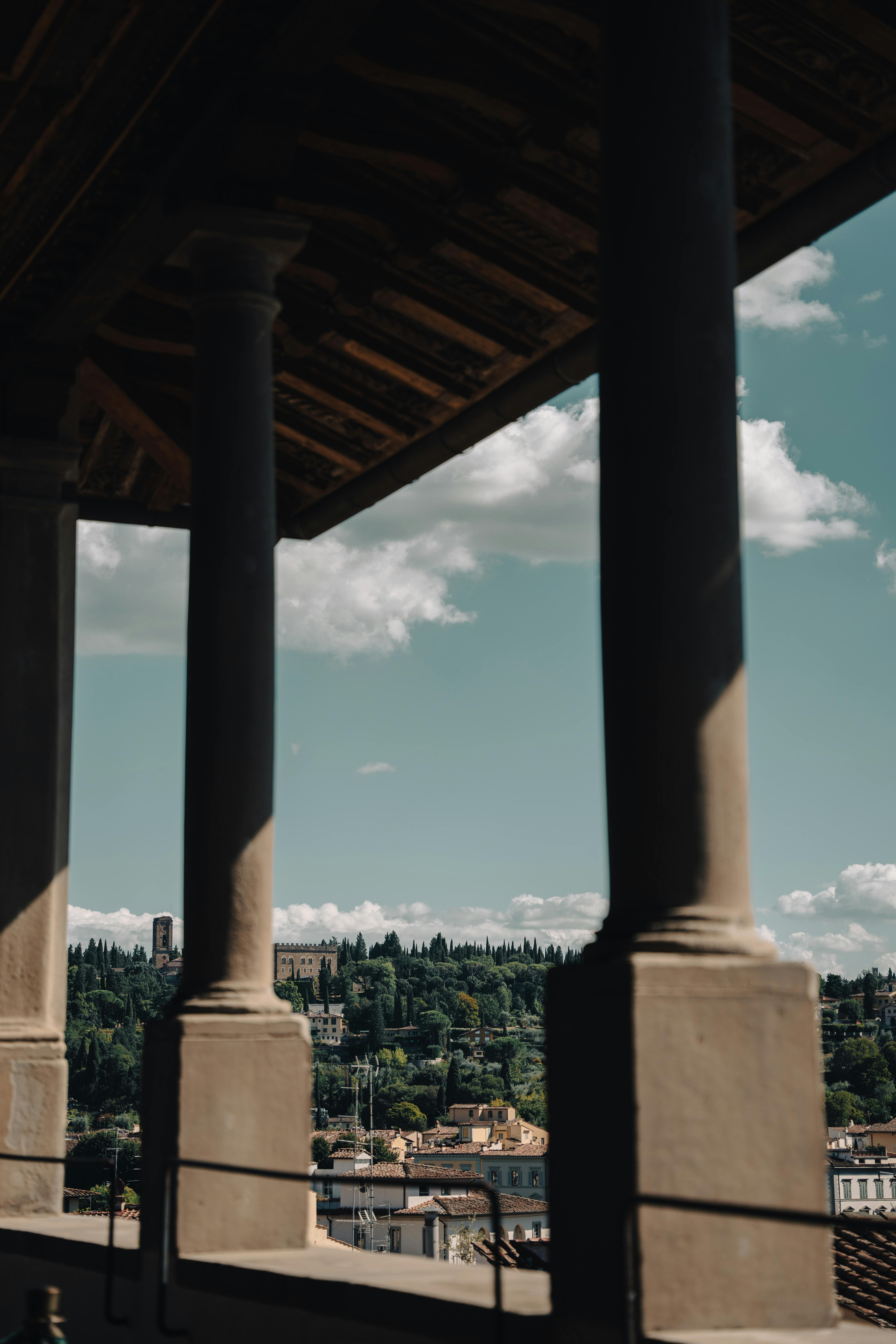 Person Sitting on Steps between Columns · Free Stock Photo