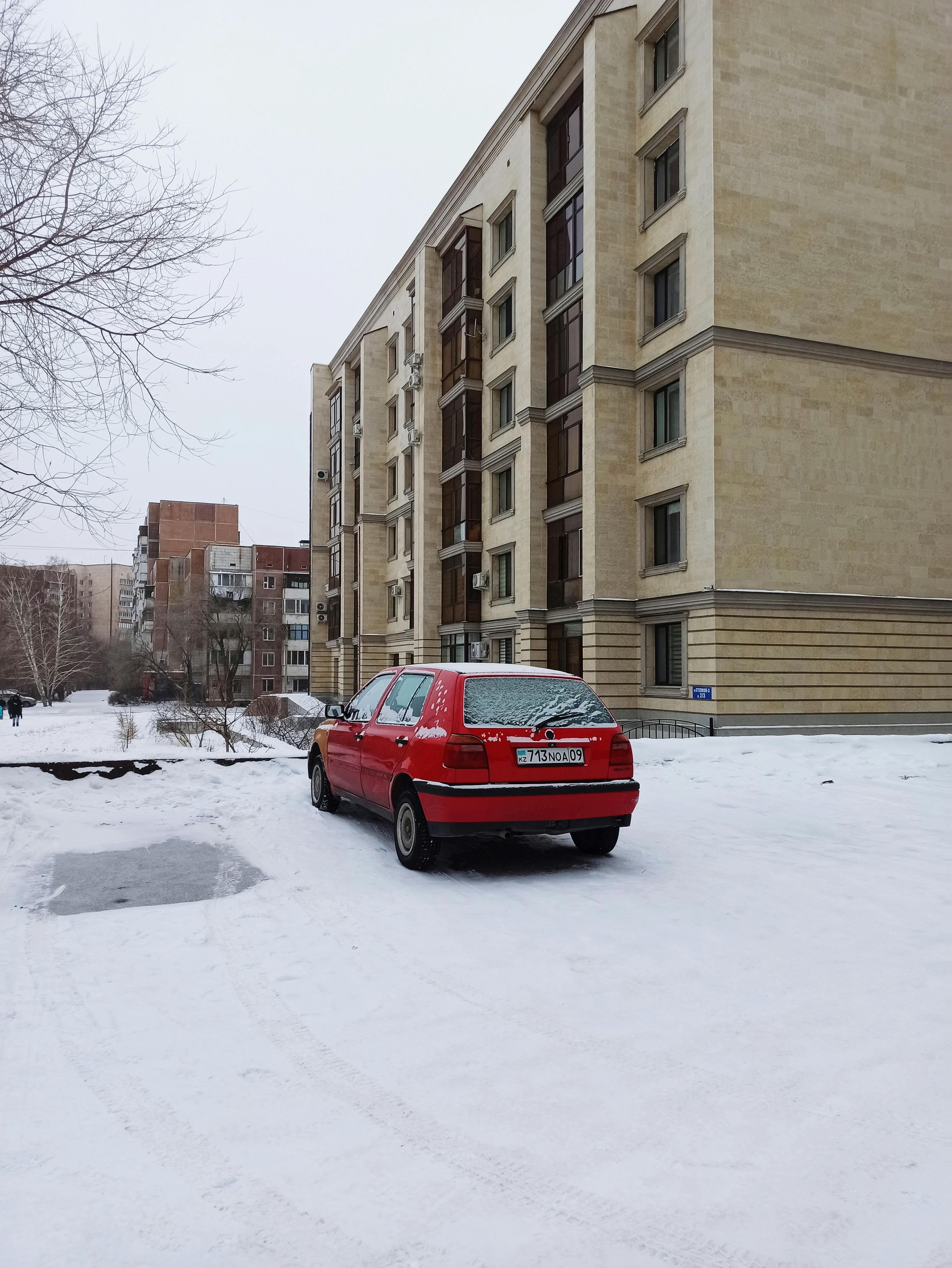 Red Car Parked Parked near a Building · Free Stock Photo
