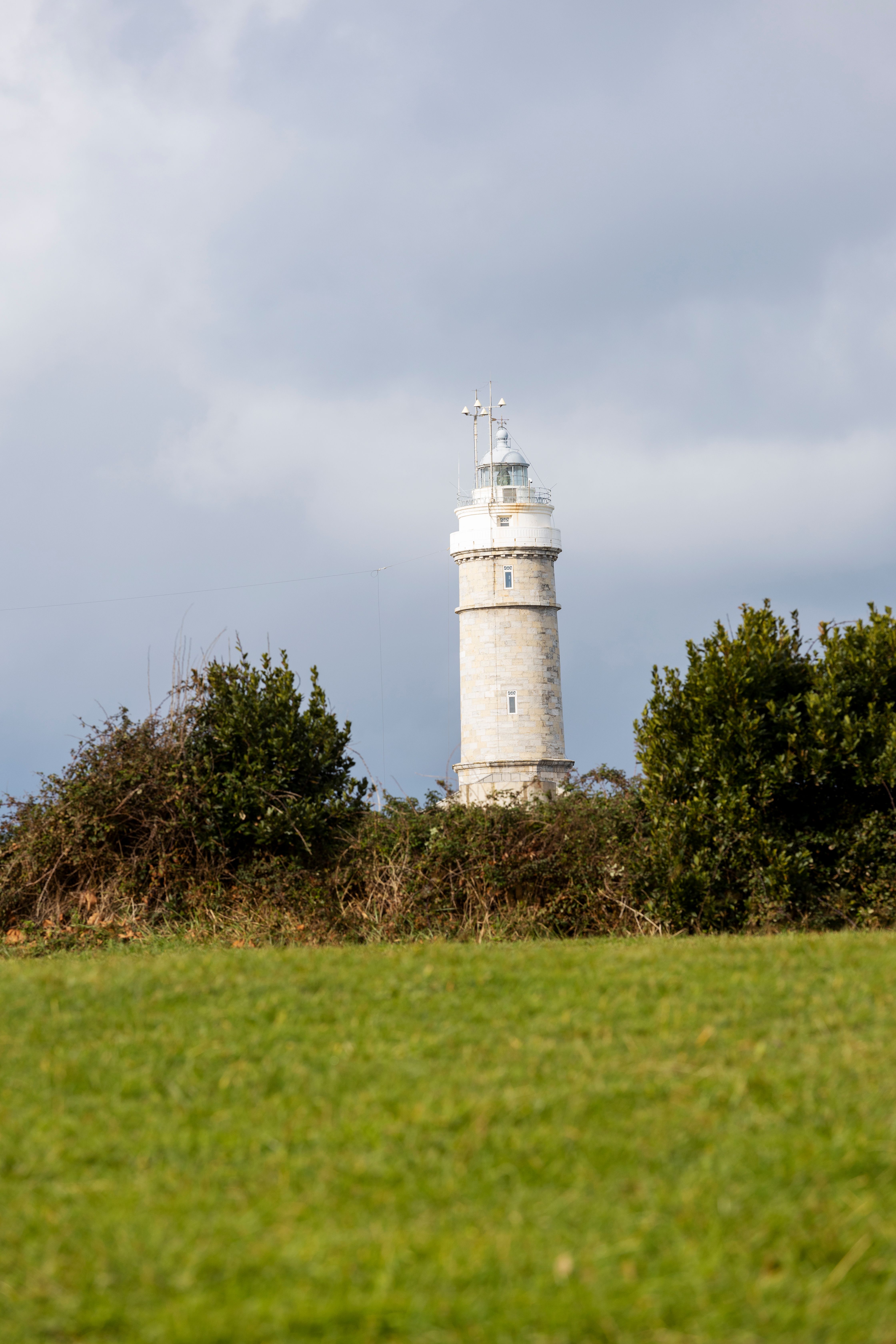 White Lighthouse Tower near Green Grass Field · Free Stock Photo