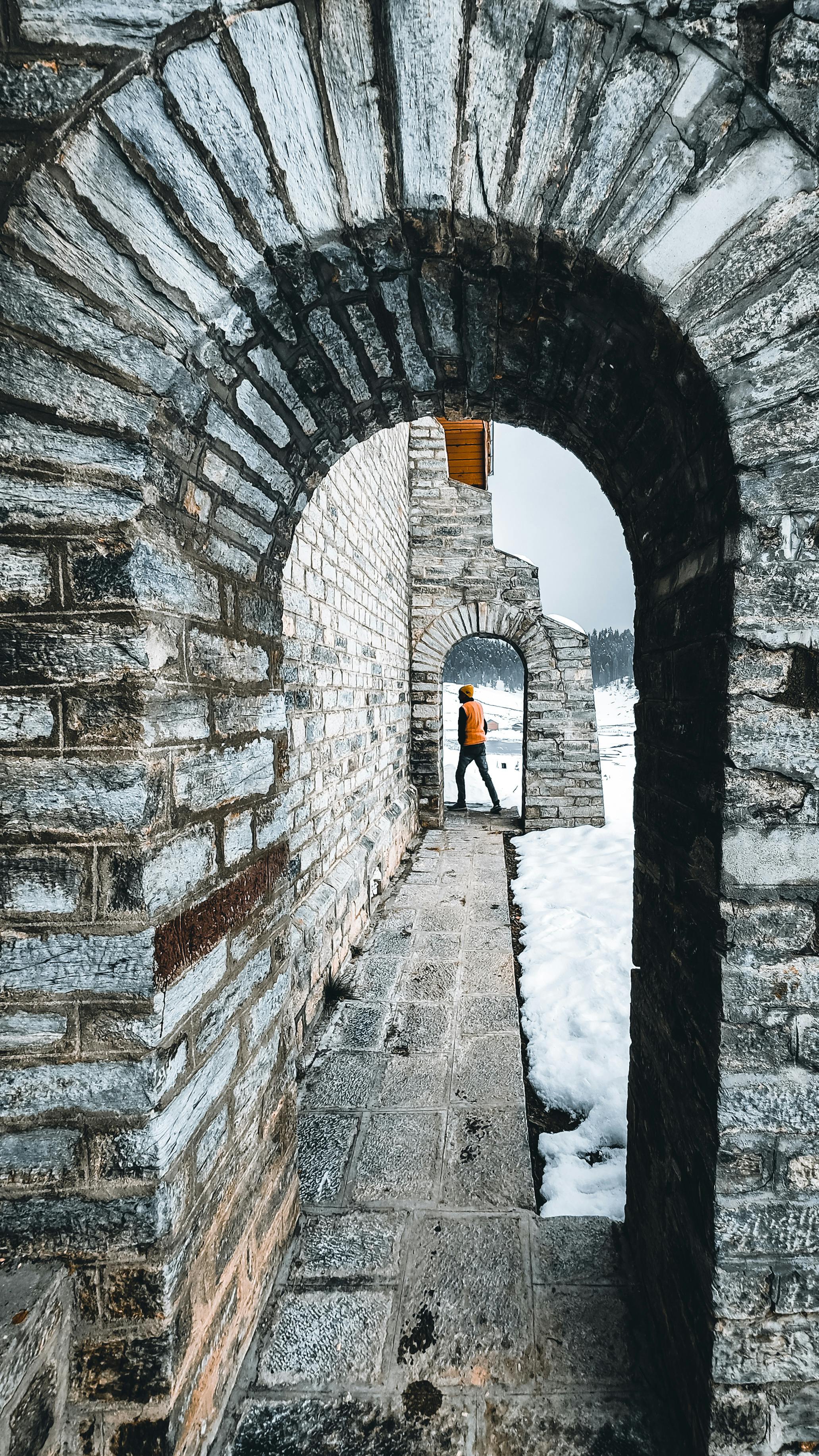 Arch and Wall of Gothic Building in Winter · Free Stock Photo