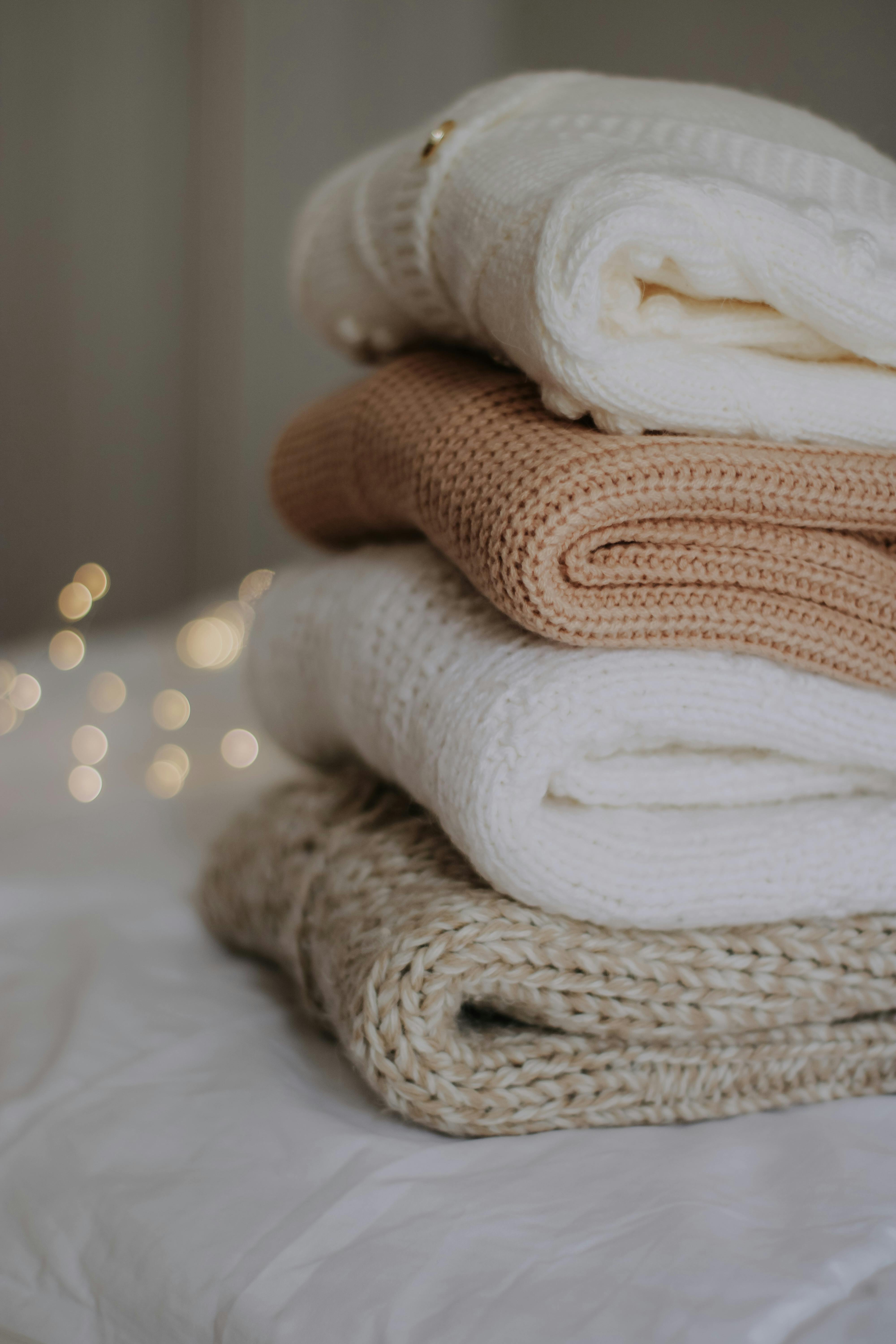 A Close-Up Shot of Folded Knitted Clothes · Free Stock Photo