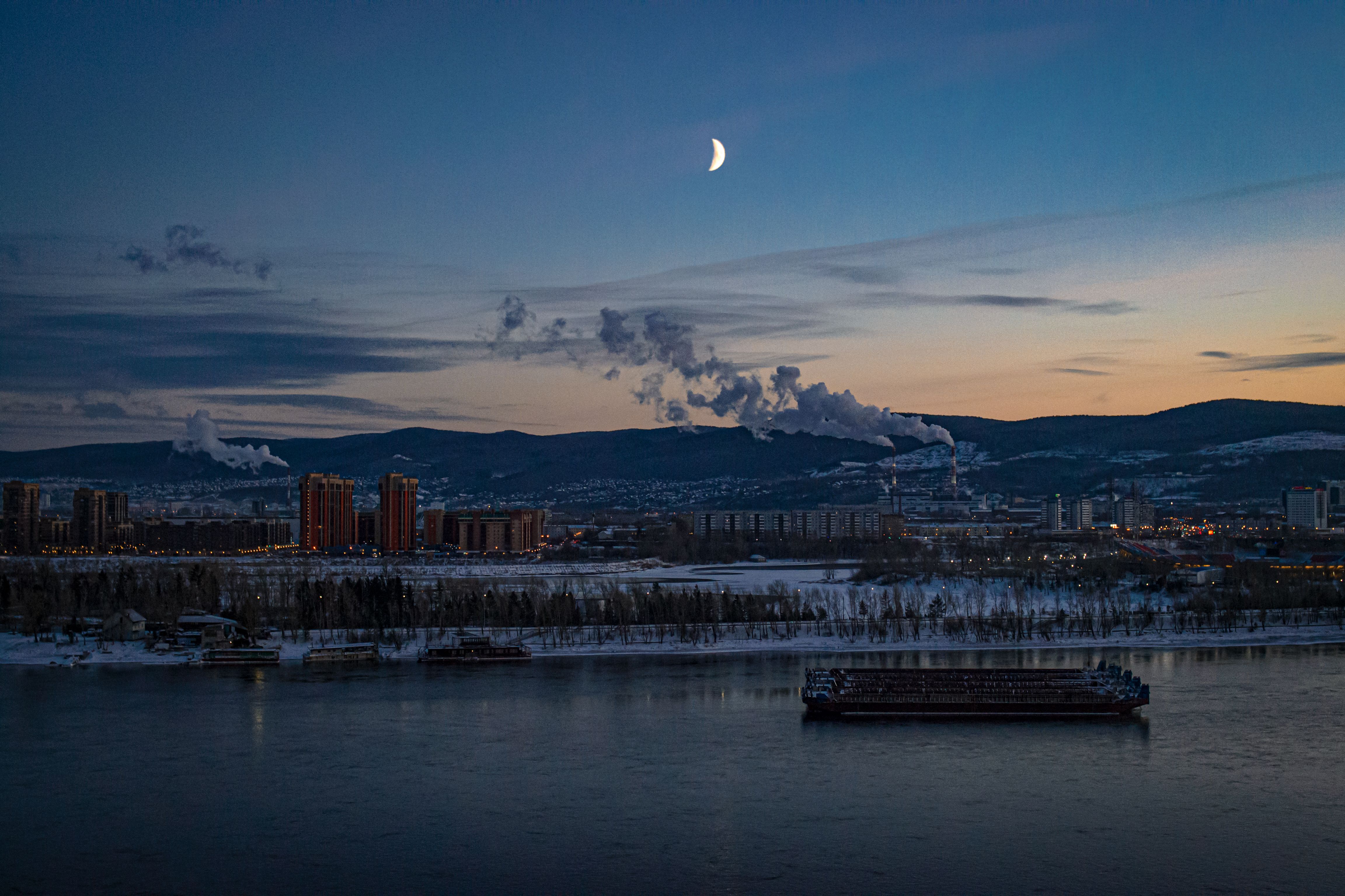 A Crescent Moon Above City Buildings · Free Stock Photo