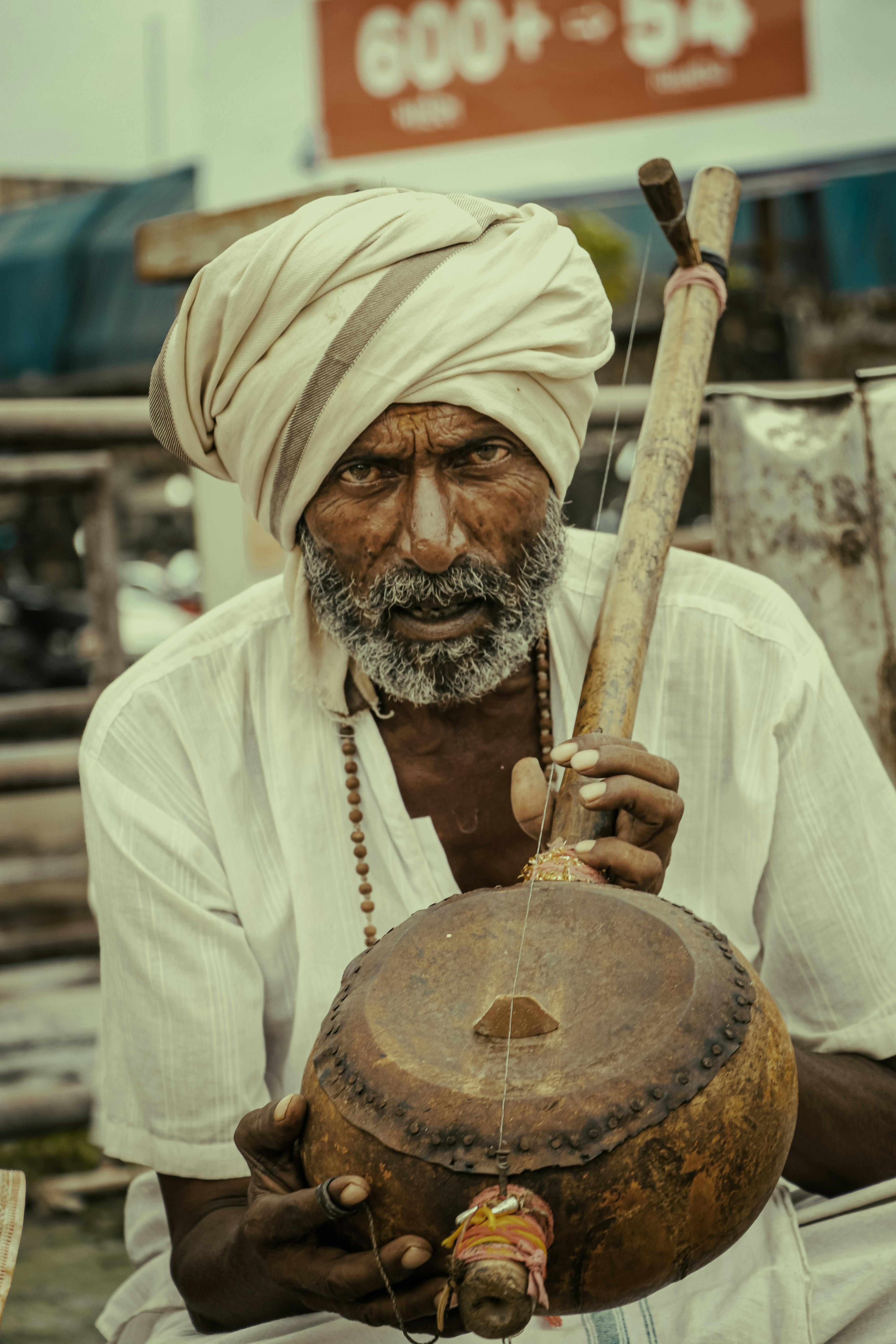 Man in Traditional Clothes Holding Set of Krakeb Instruments · Free ...