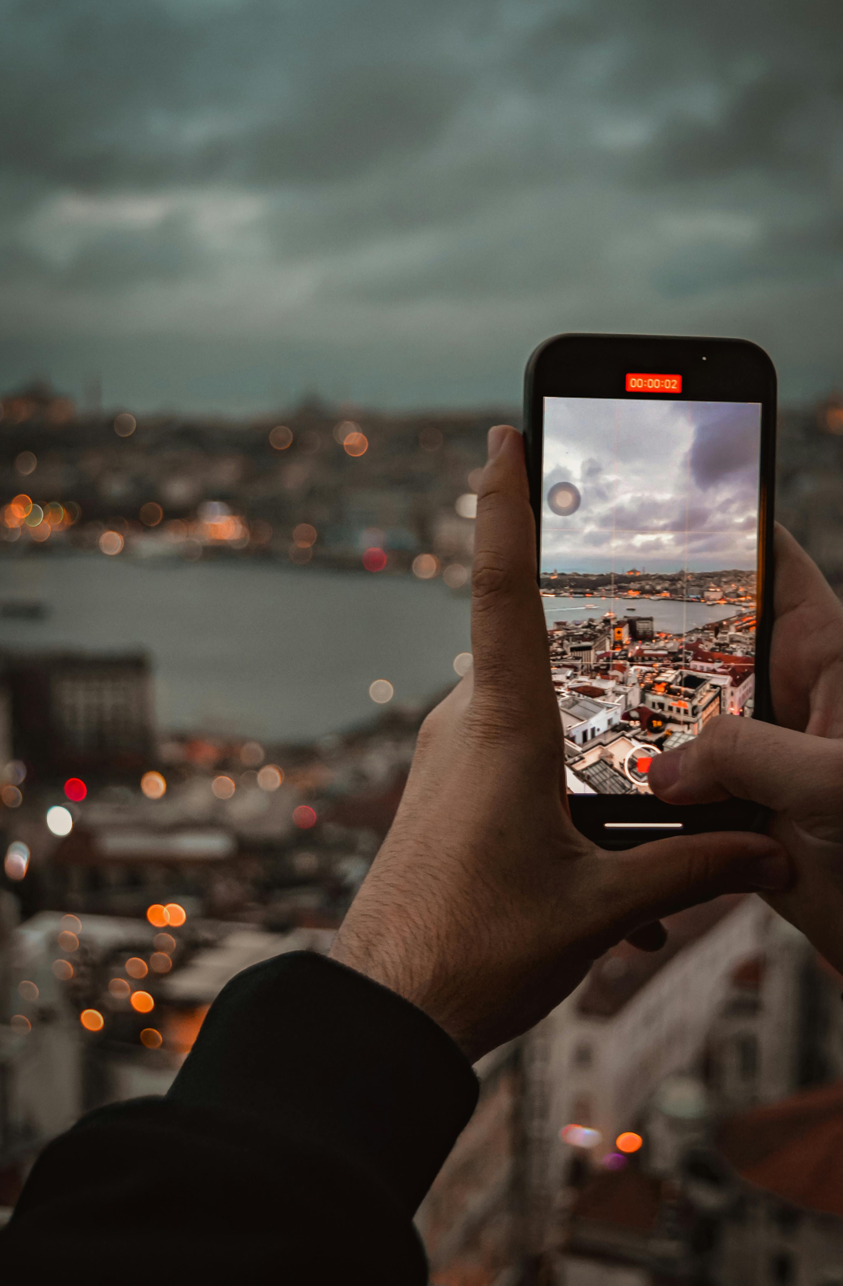 Close up of Woman Hand Recording Video of Street in Town · Free Stock Photo