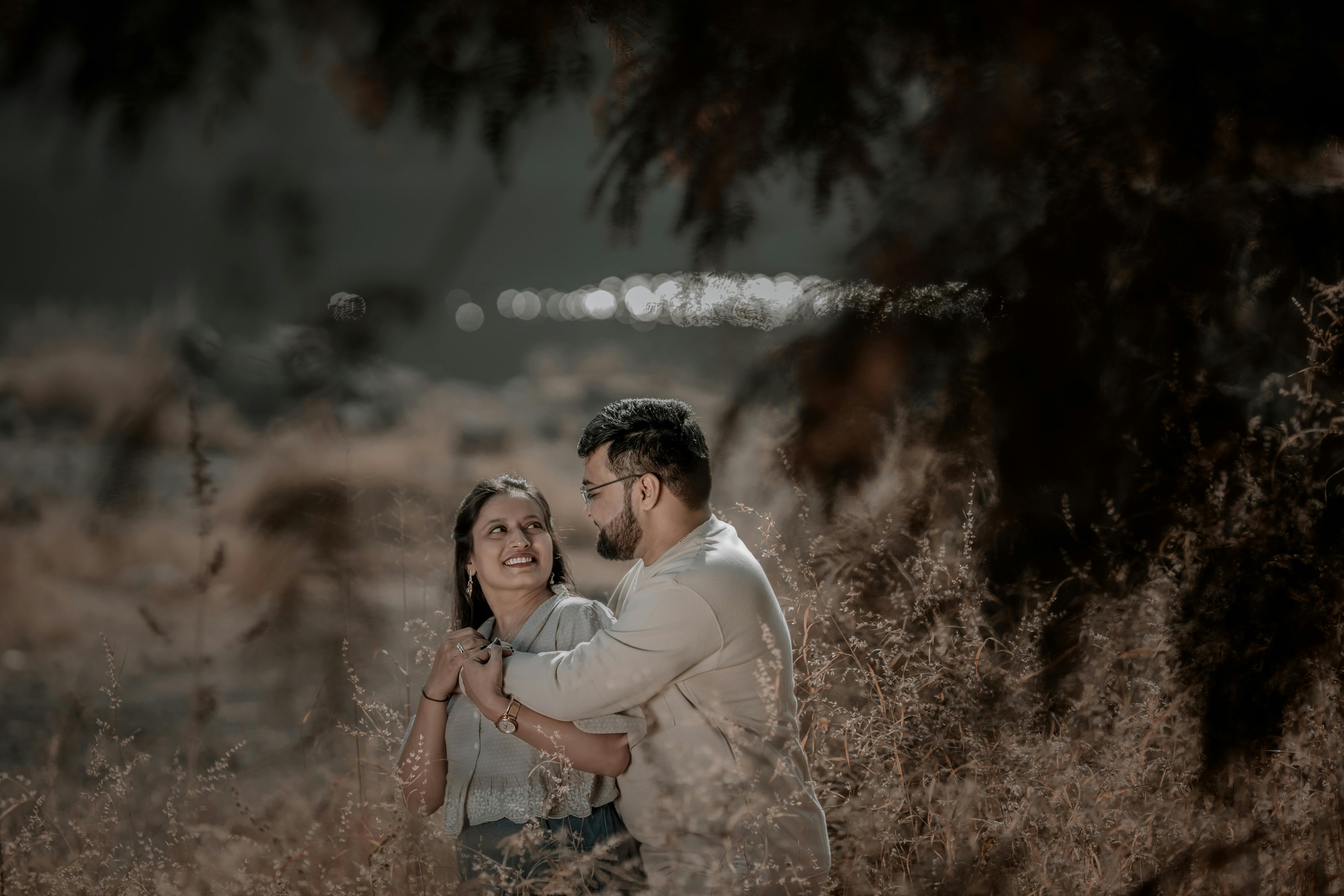 A Man Carrying a Woman while in a Shore · Free Stock Photo