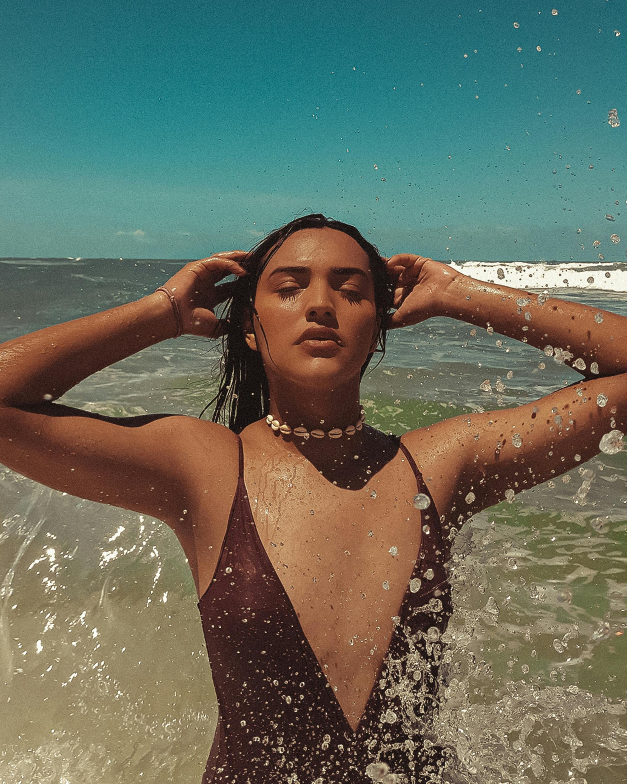 Beautiful Woman Lying on the Beach Submerged in Sea Water · Free Stock Photo