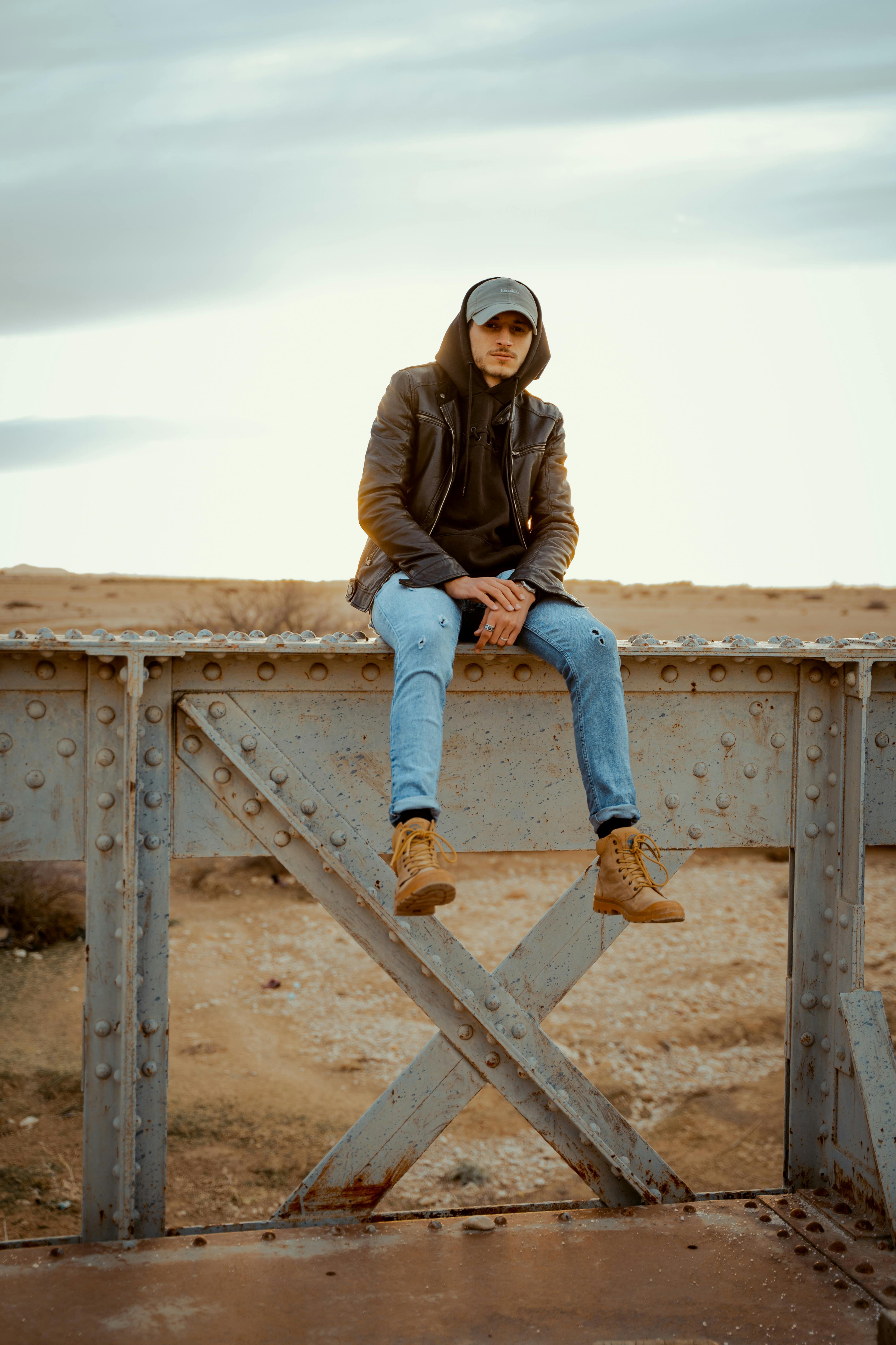Man Posing in Cap and Jacket · Free Stock Photo
