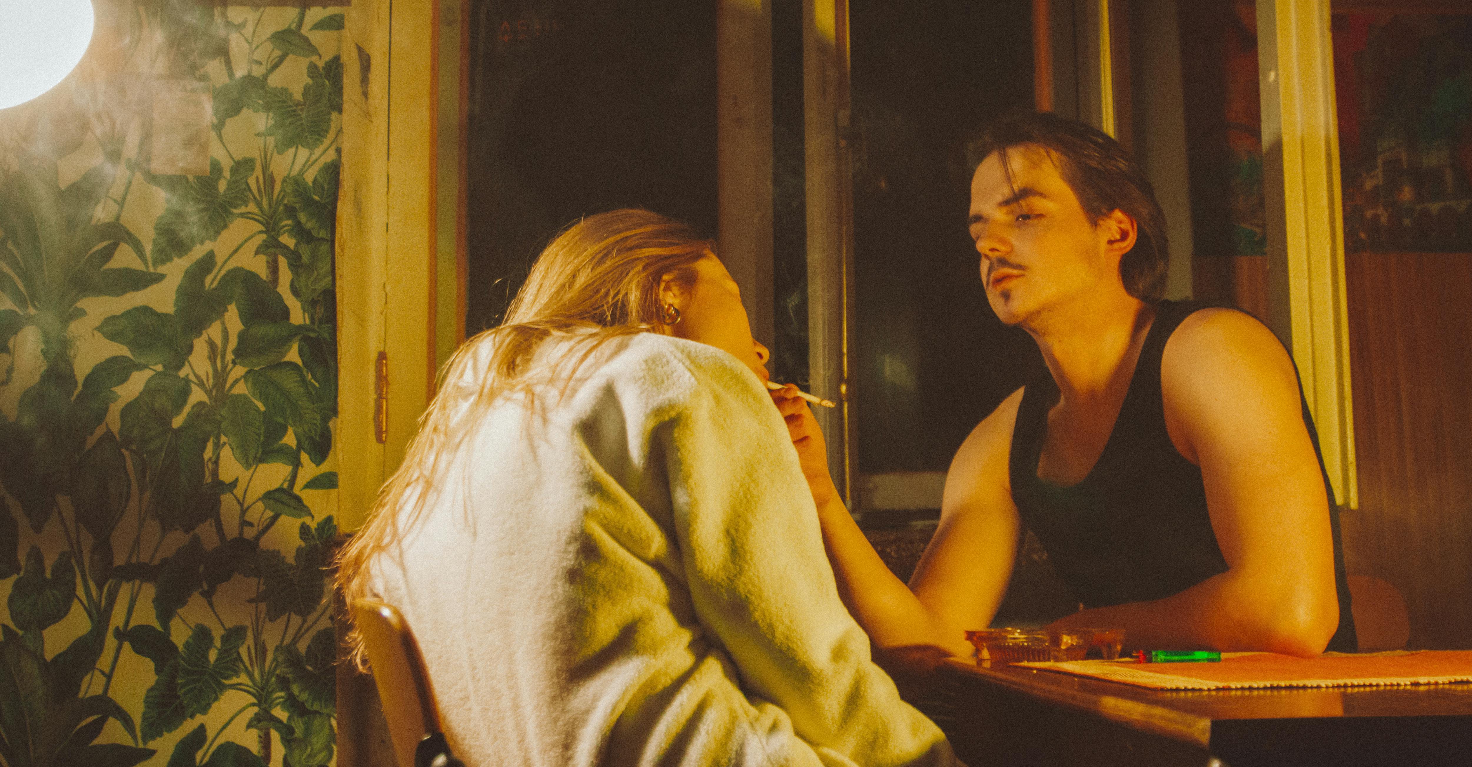 Couple Smoking a Cigarette · Free Stock Photo