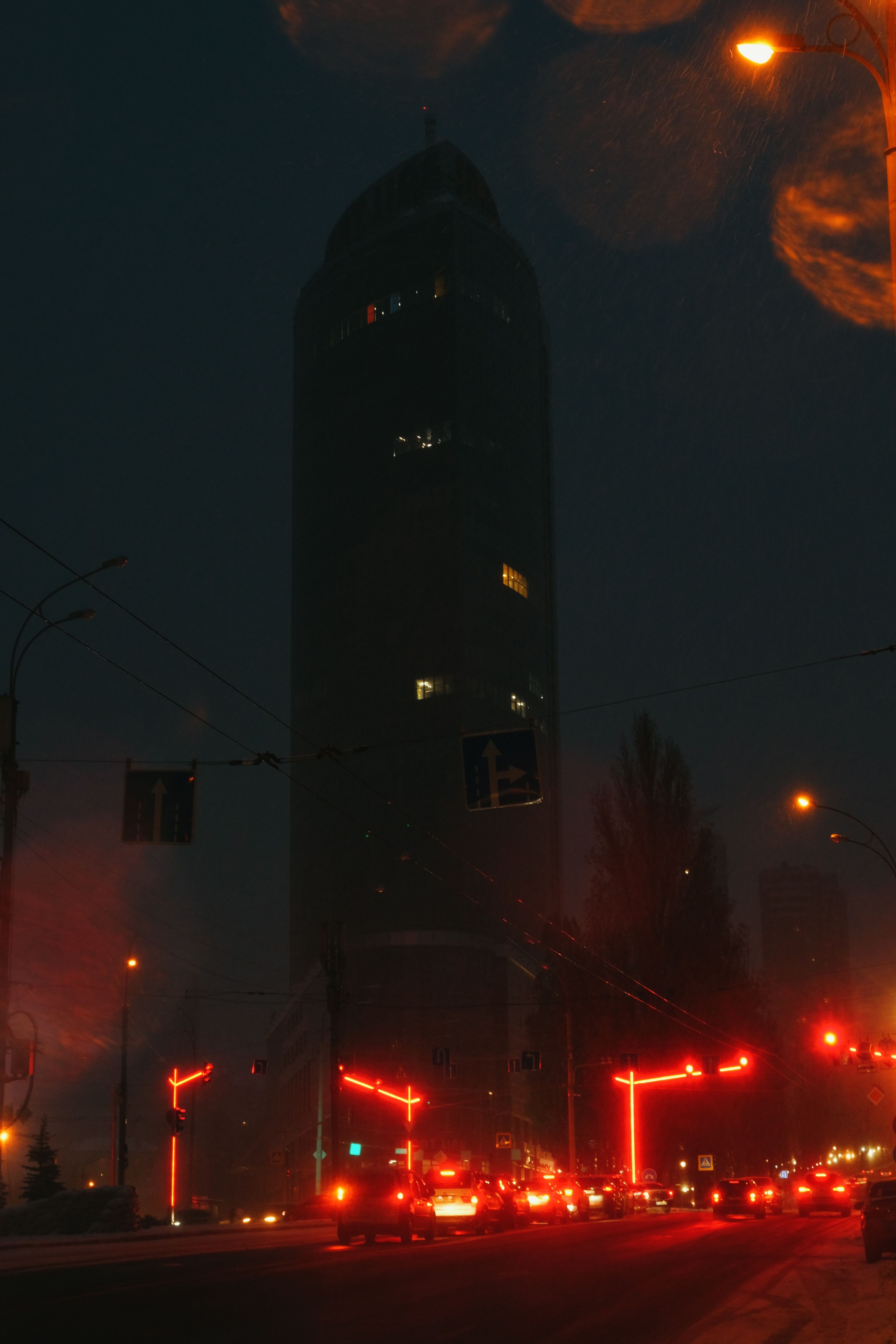 Red Illuminated Street by Skyscraper · Free Stock Photo