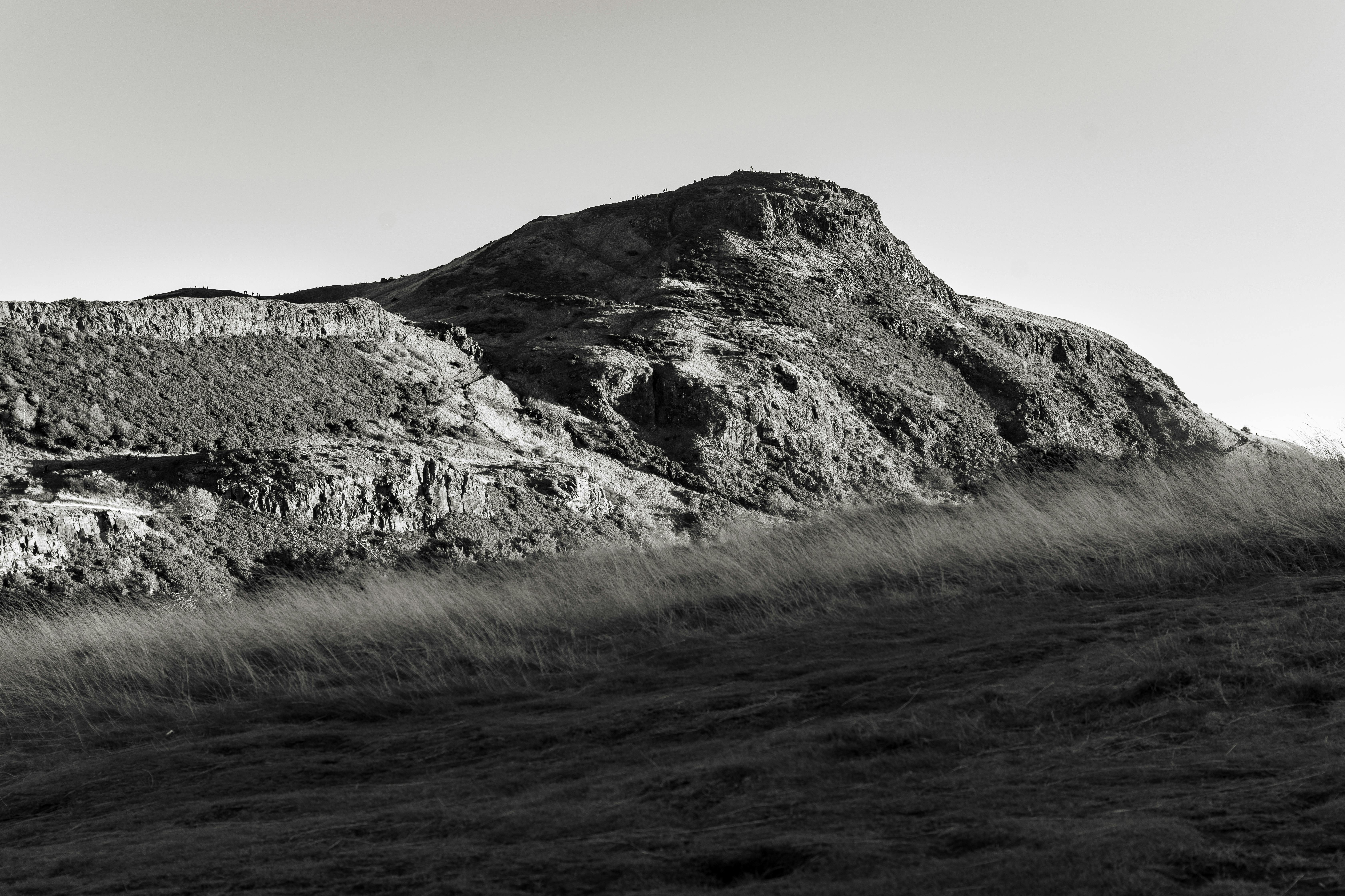 Grass Field Between Two Mountains · Free Stock Photo