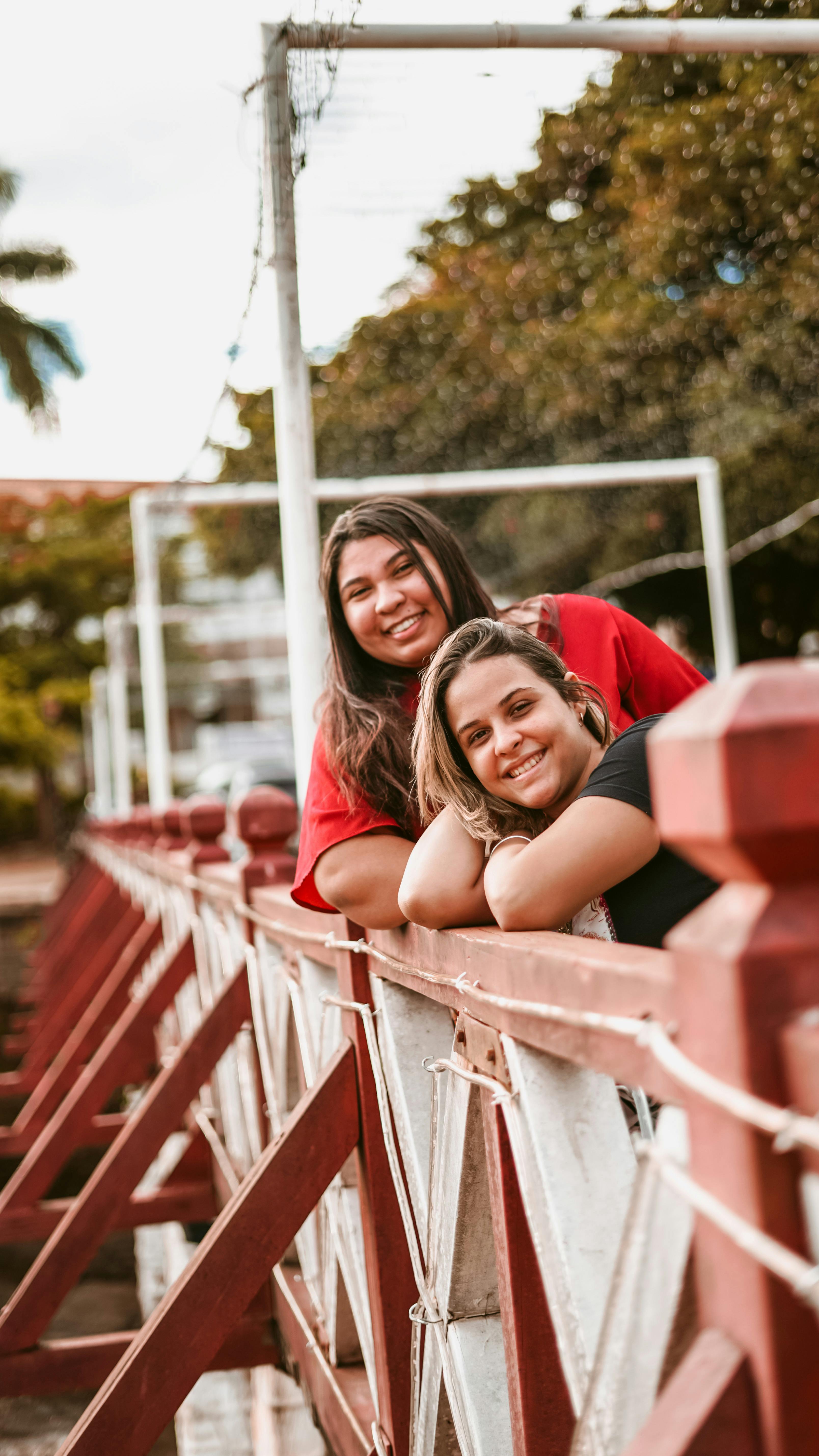 Women Leaning on Railing · Free Stock Photo