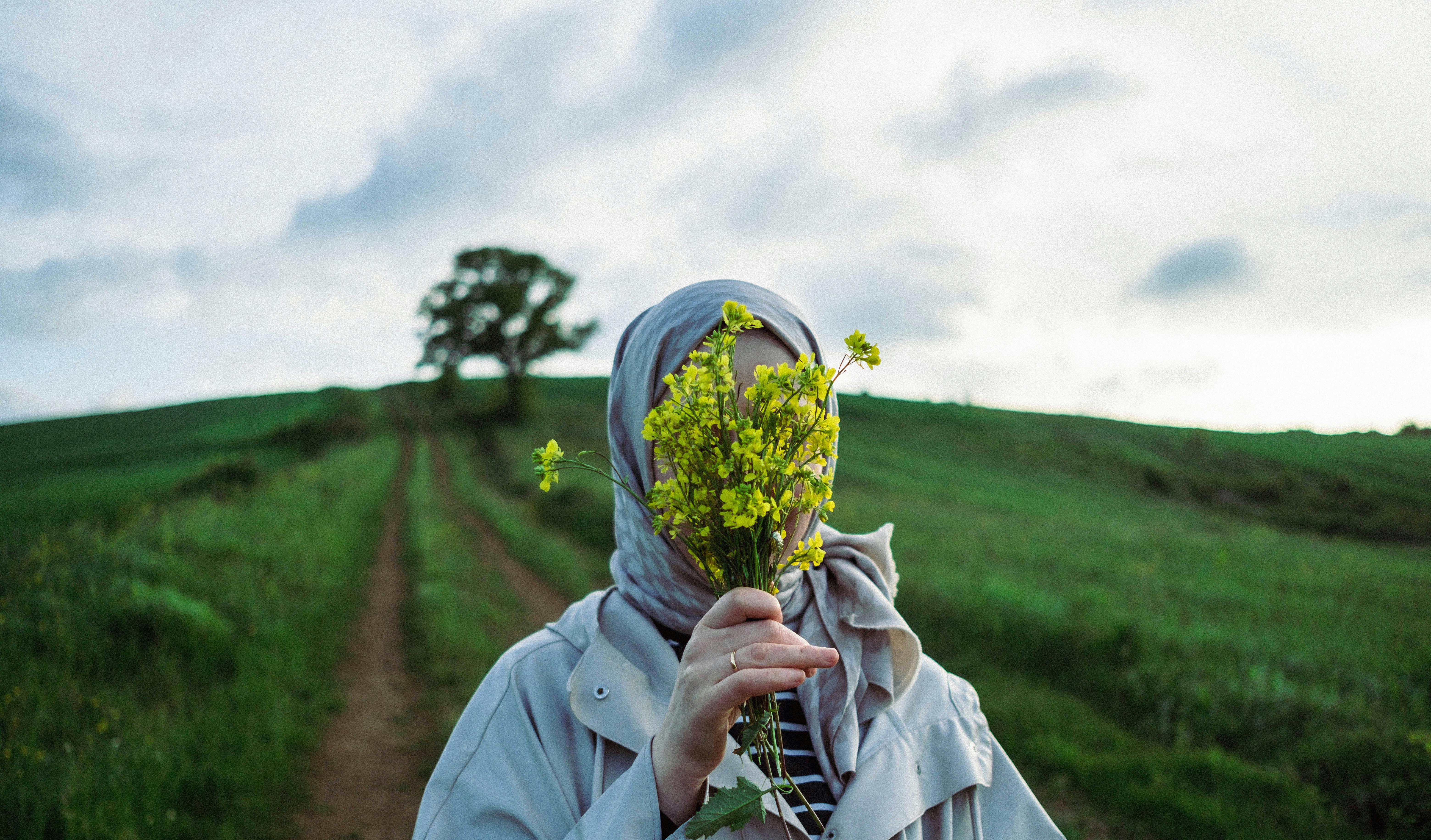 Woman Covering Face with Bunch of Flowers · Free Stock Photo