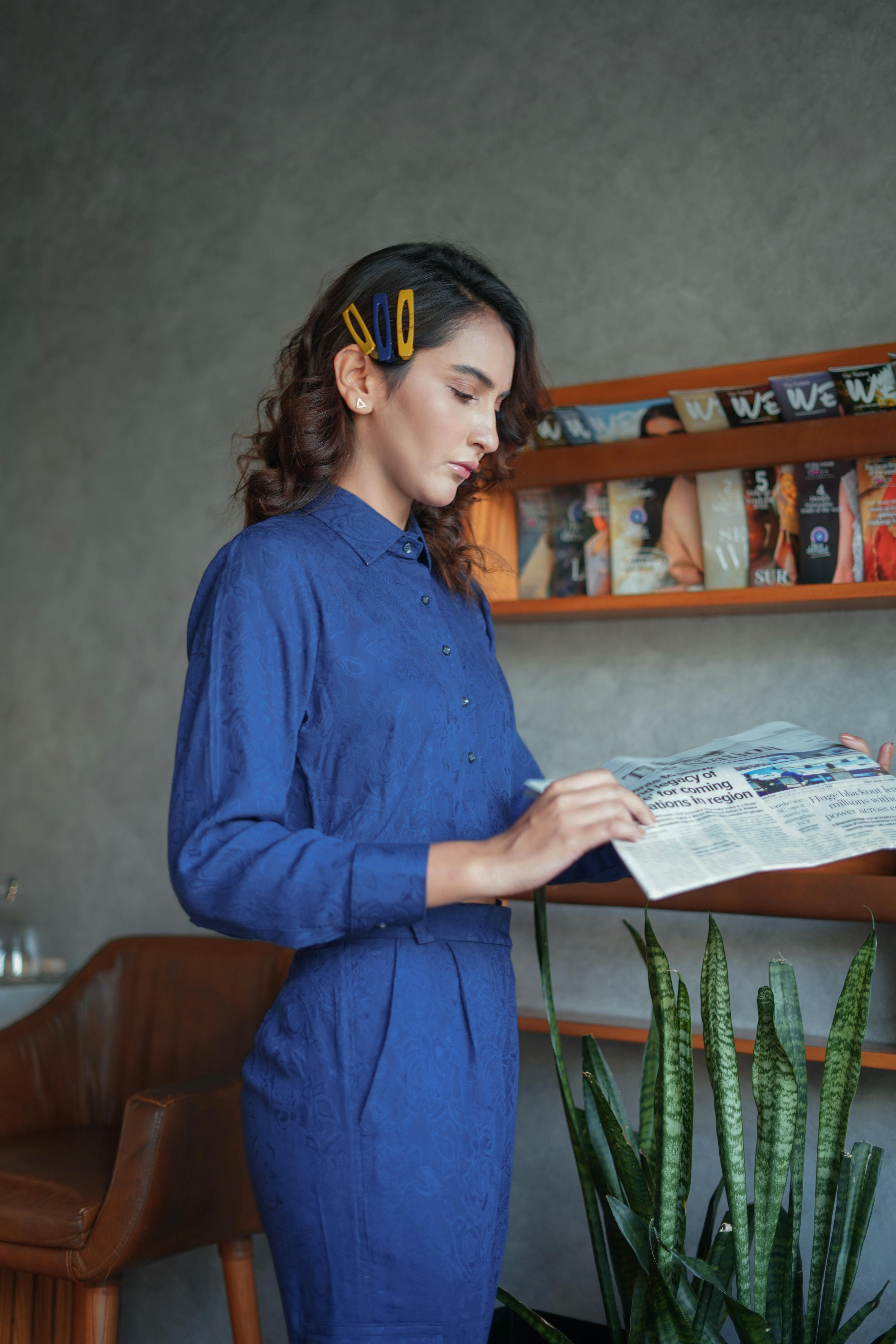 Woman in White Robe Reading Newspaper · Free Stock Photo