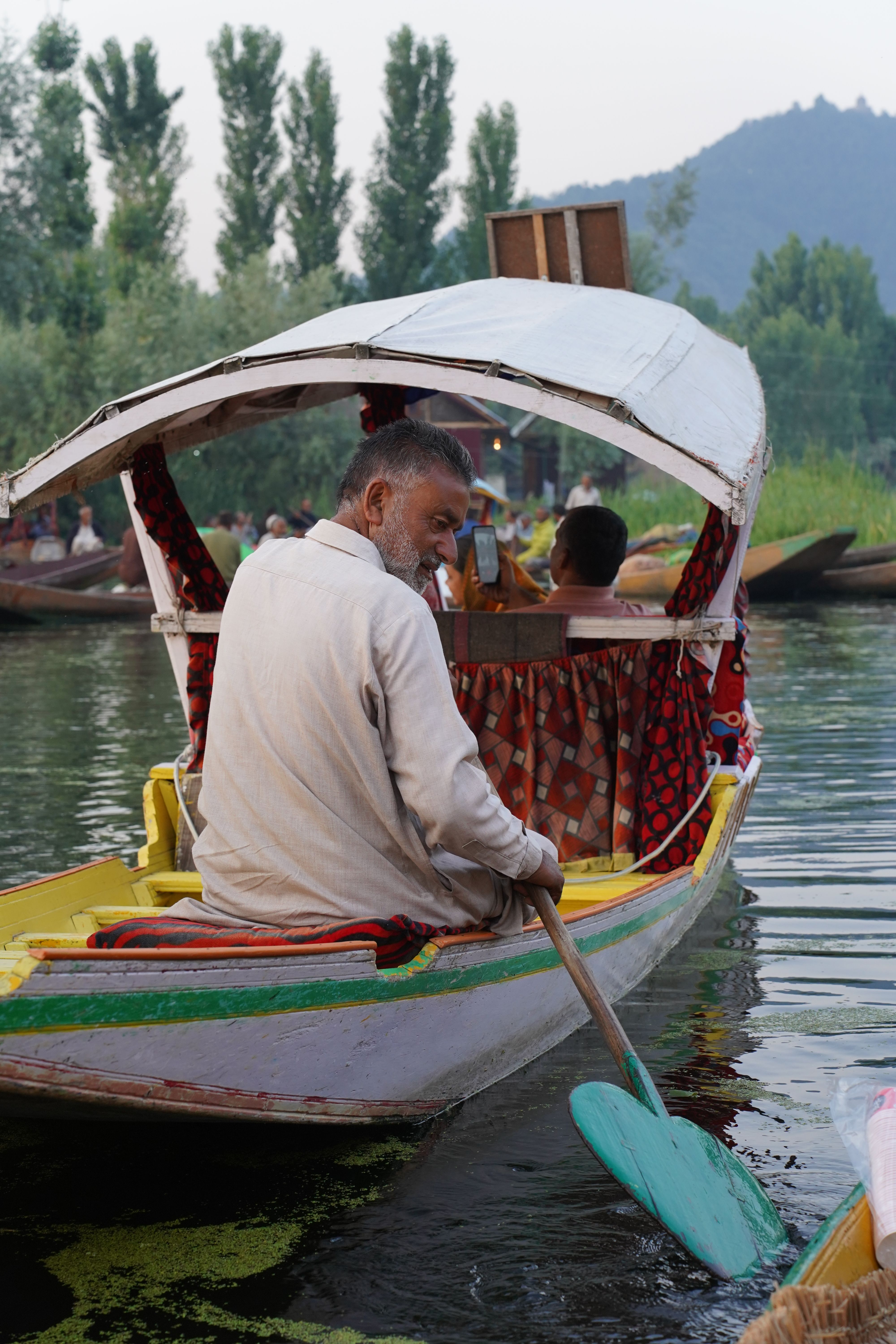 A Standing Man Paddling a Boat · Free Stock Photo