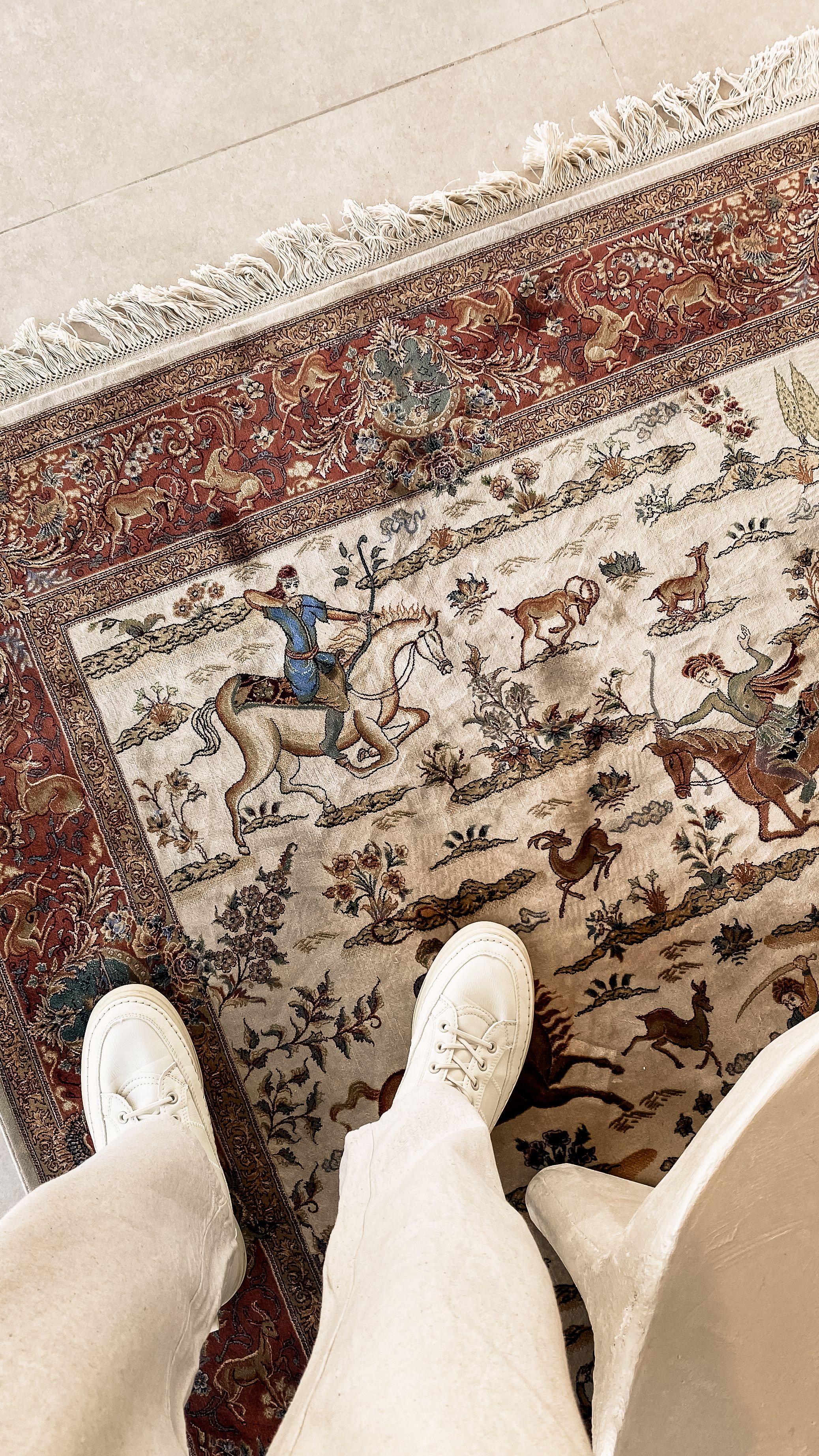 High Angle View of White Trousers and Shoes on a Patterned Carpet ...