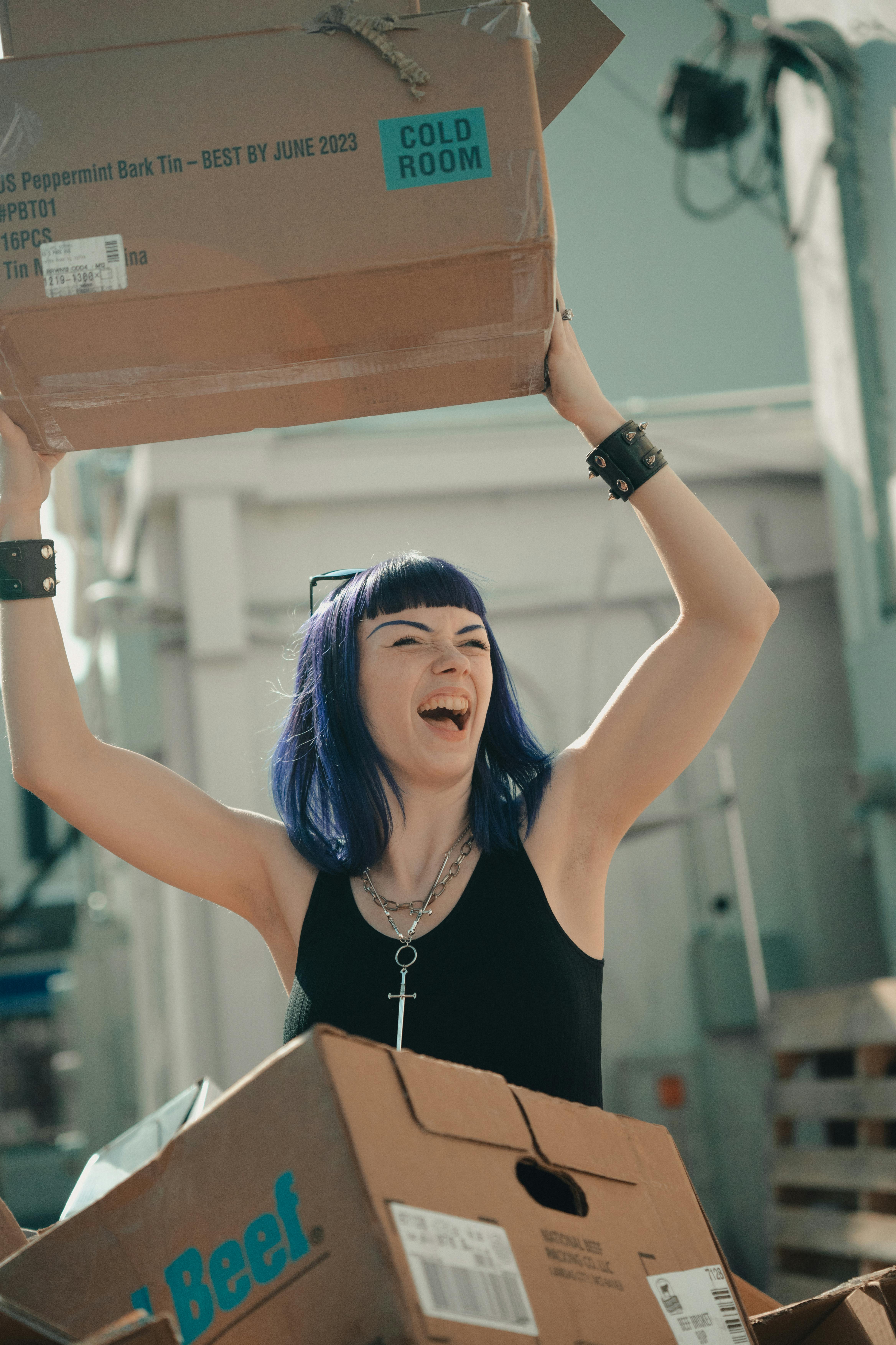 Laughing Woman Carrying a Box · Free Stock Photo