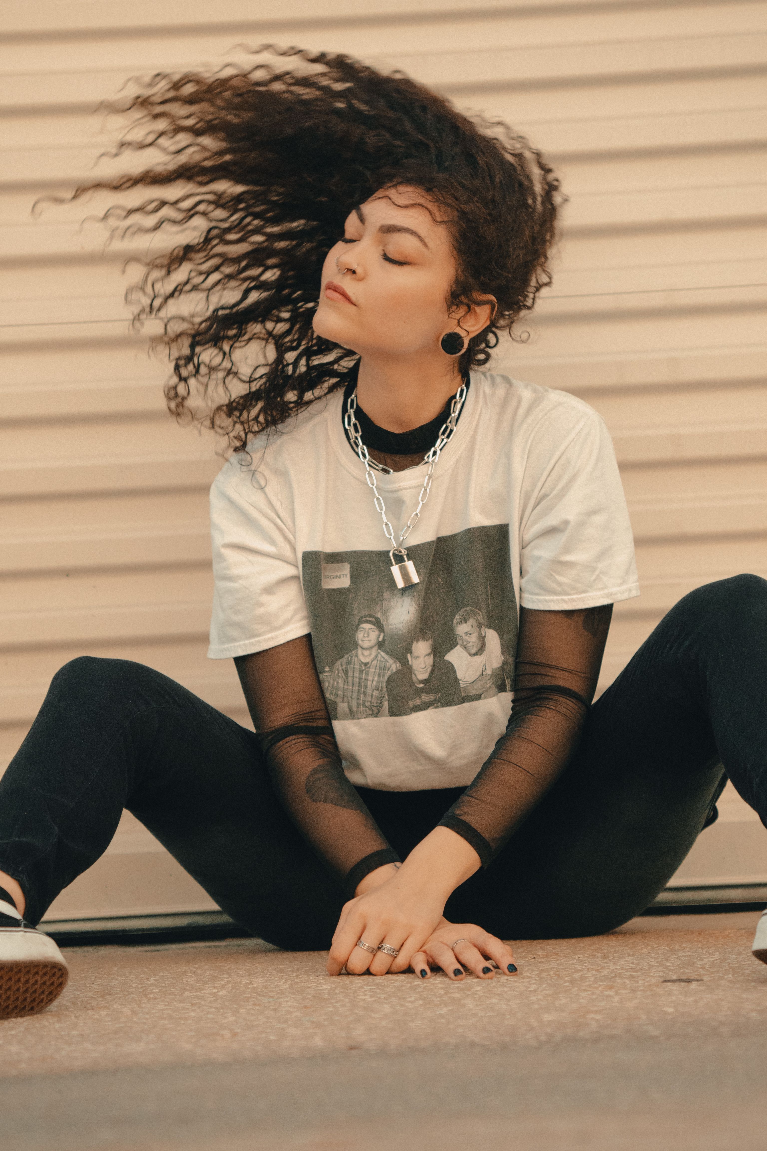 A Woman with Curly Hair Sitting on the Floor · Free Stock Photo