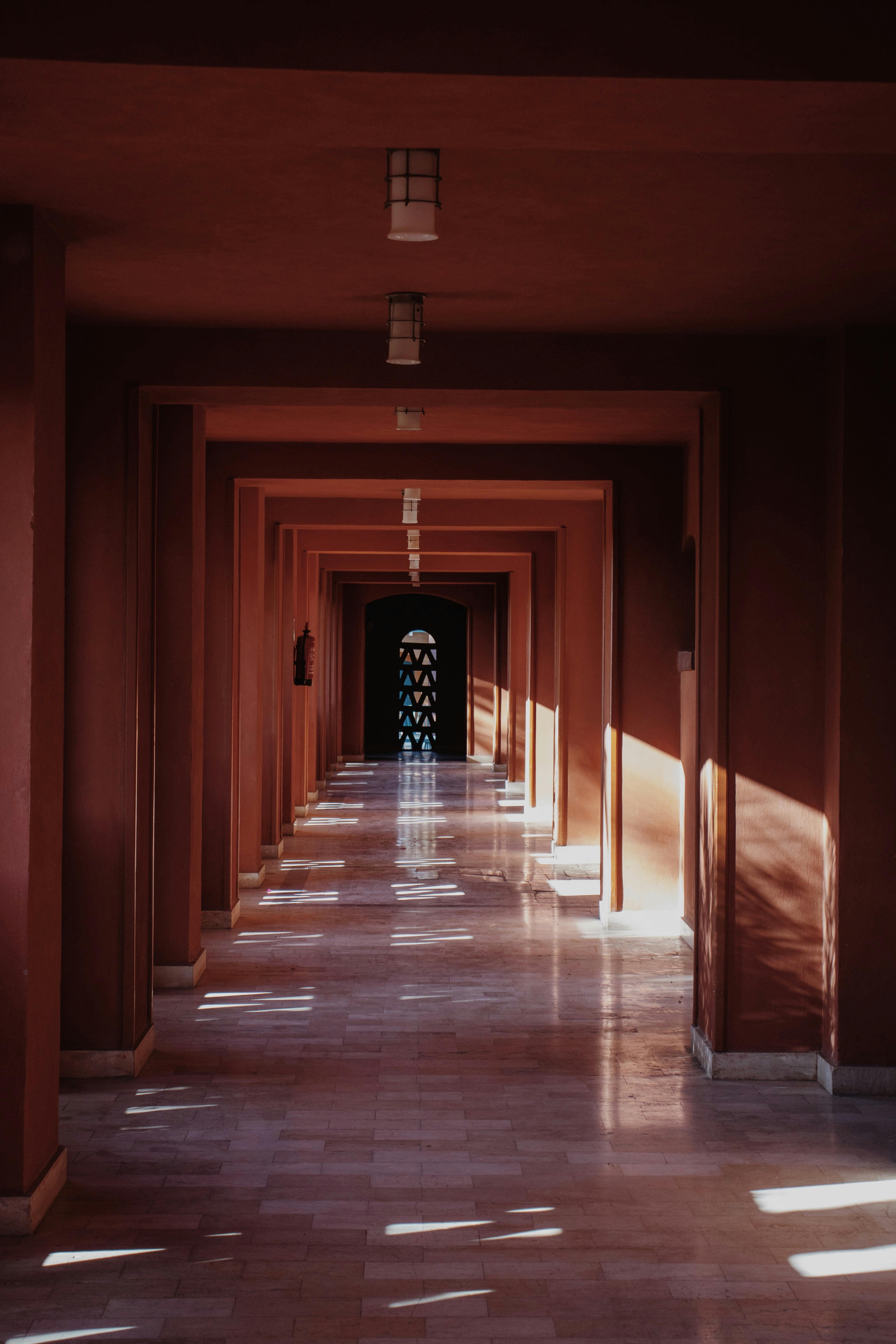 Symmetrical View of a Corridor with Door at the End · Free Stock Photo