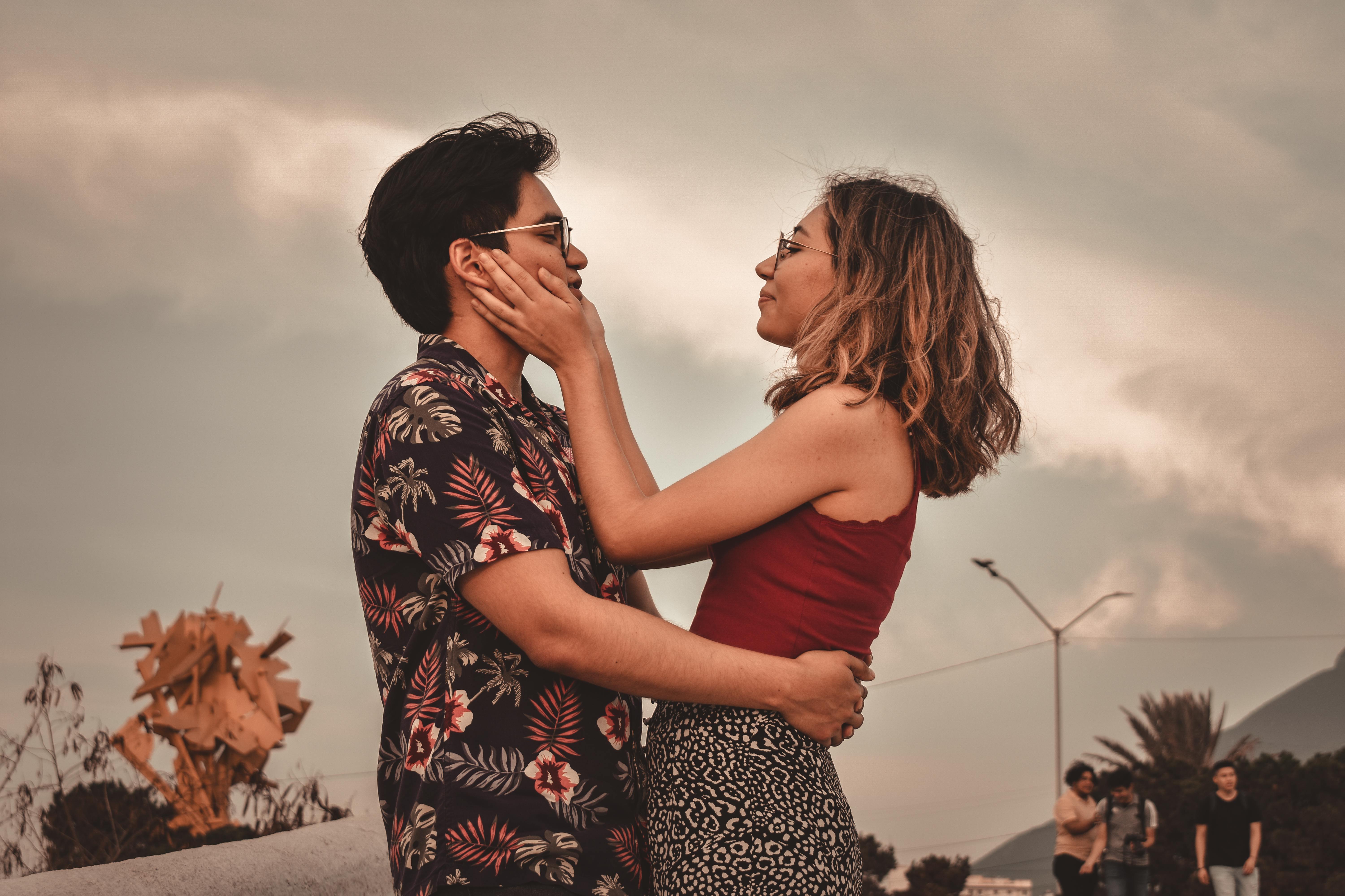 Woman Looking at the Man's Face while Touching his Nape · Free Stock Photo