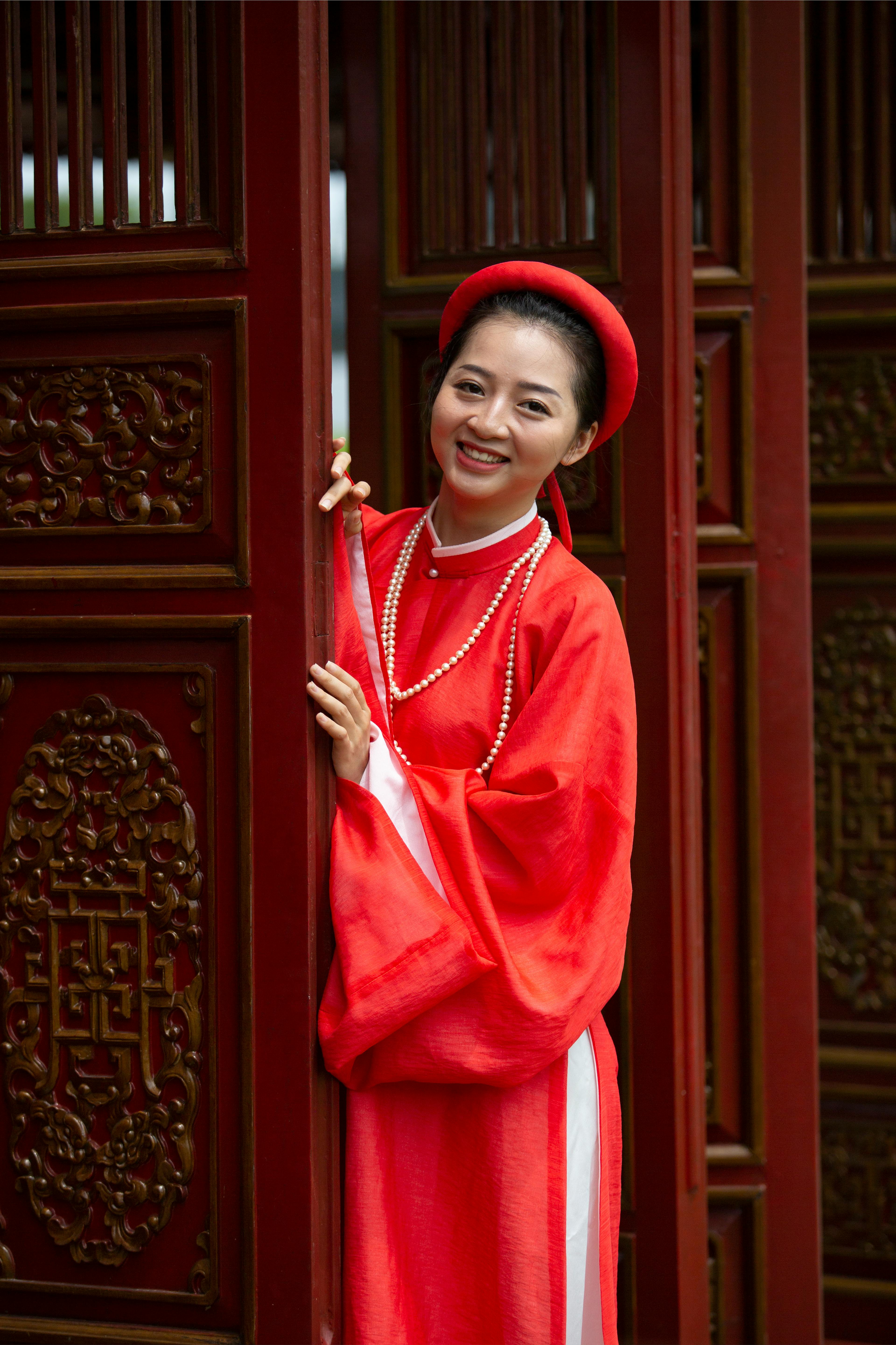 A Woman in Red Traditional Clothes Smiling · Free Stock Photo