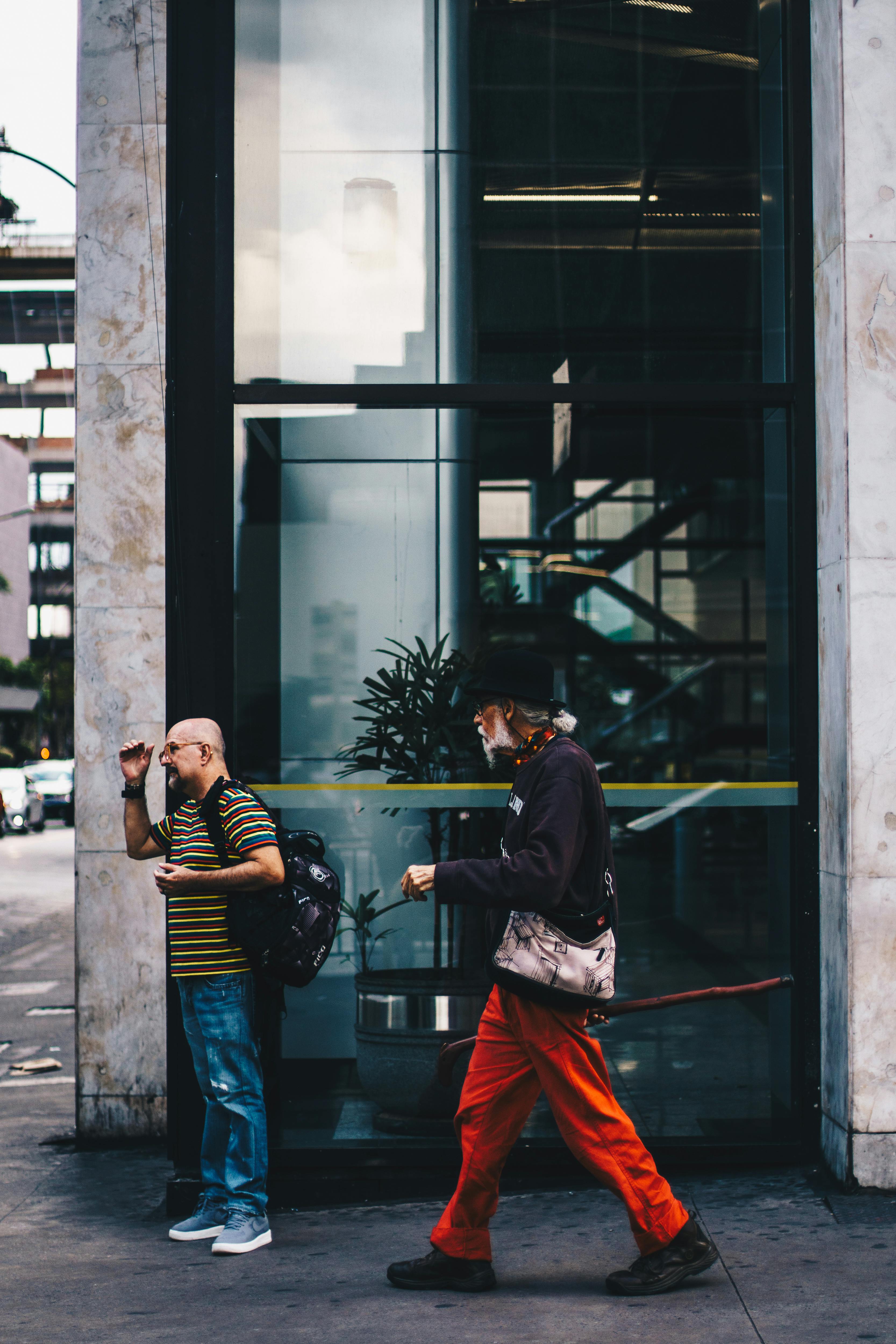 Man Walking Near Man Standing · Free Stock Photo