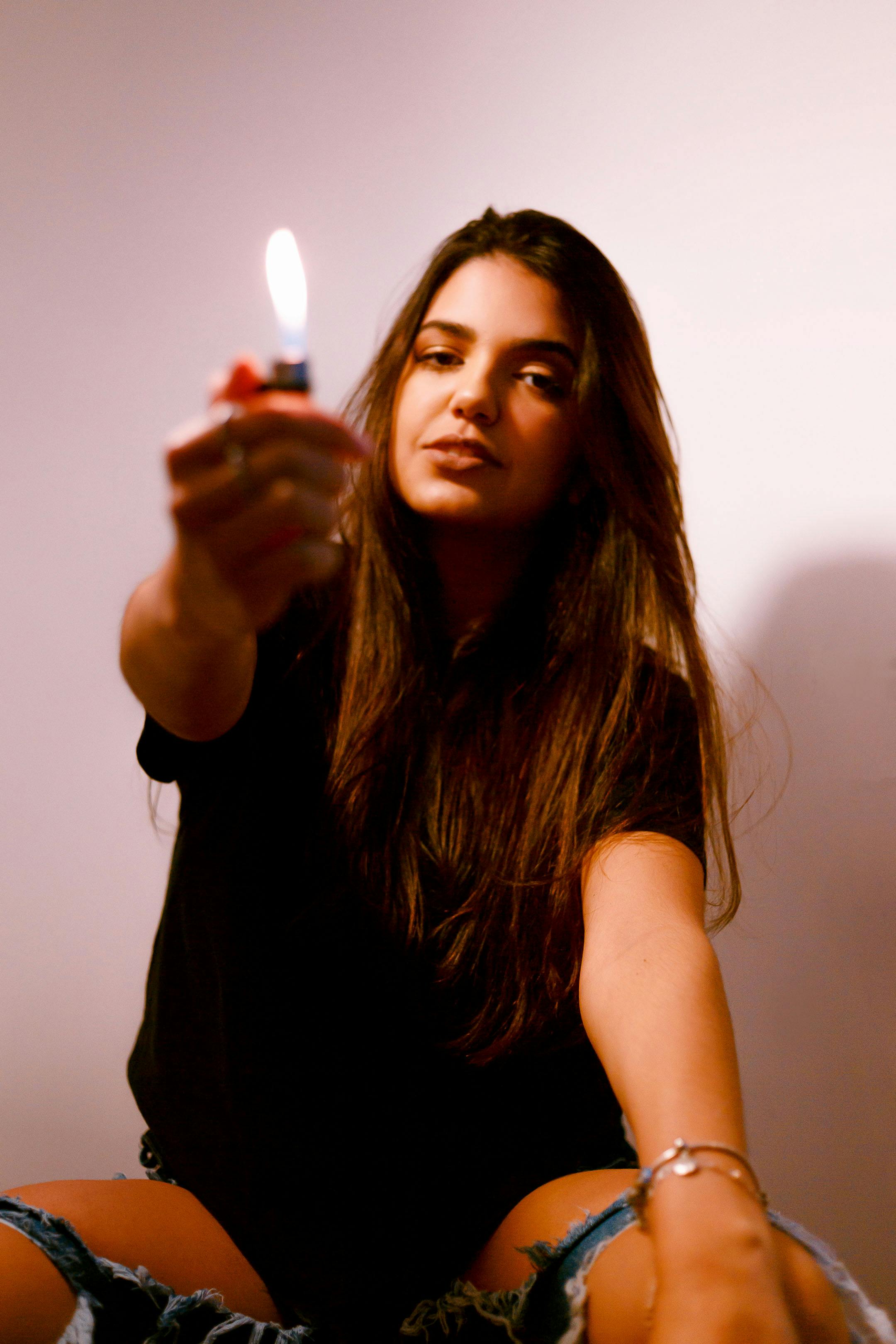 Woman Posing with Lighter in Darkness · Free Stock Photo