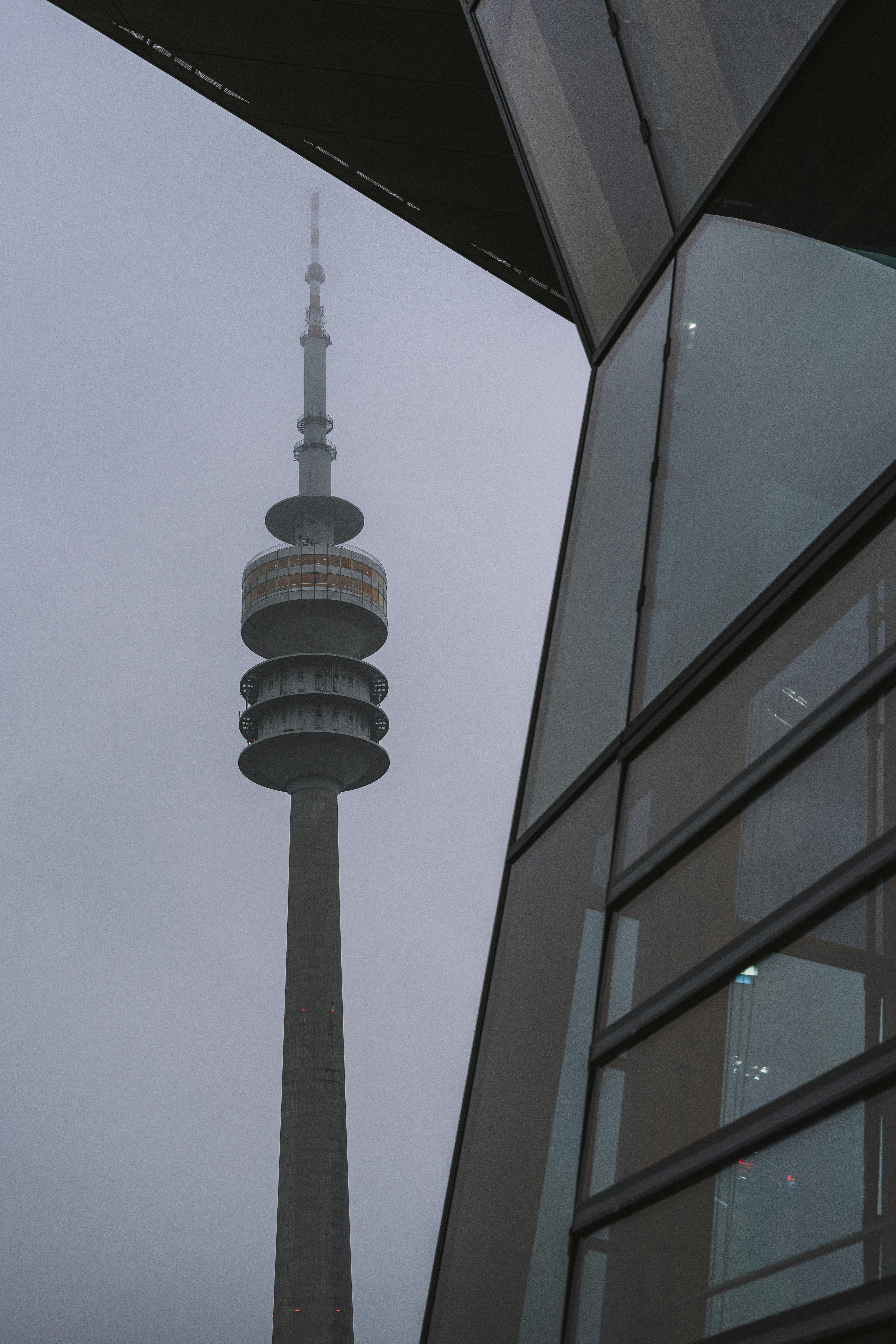 A Tower Near Glass Building · Free Stock Photo